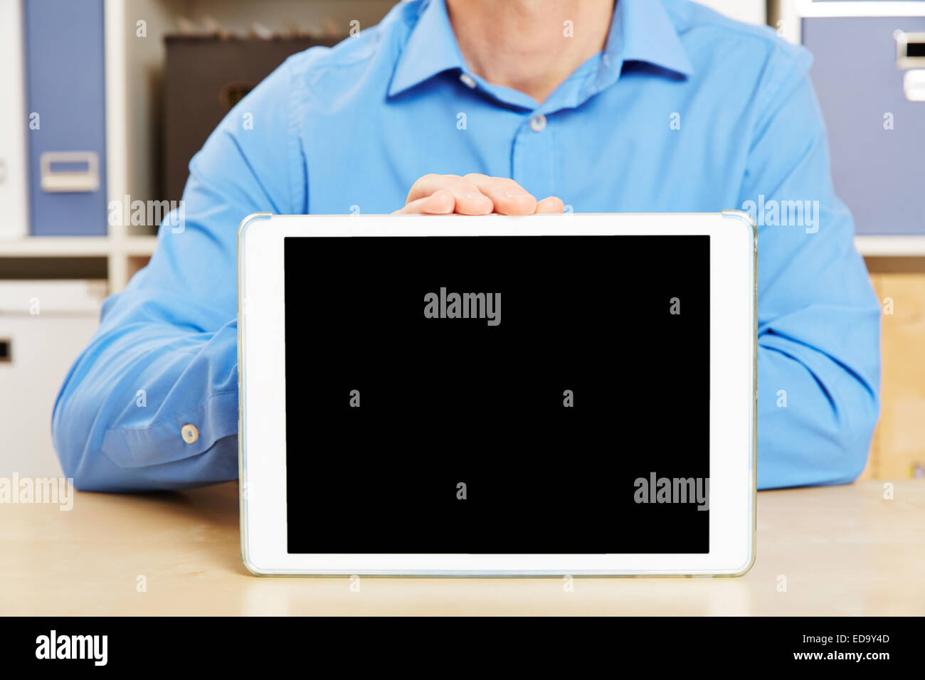Hand holding tablet PC with empty black screen on office desk Stock ...