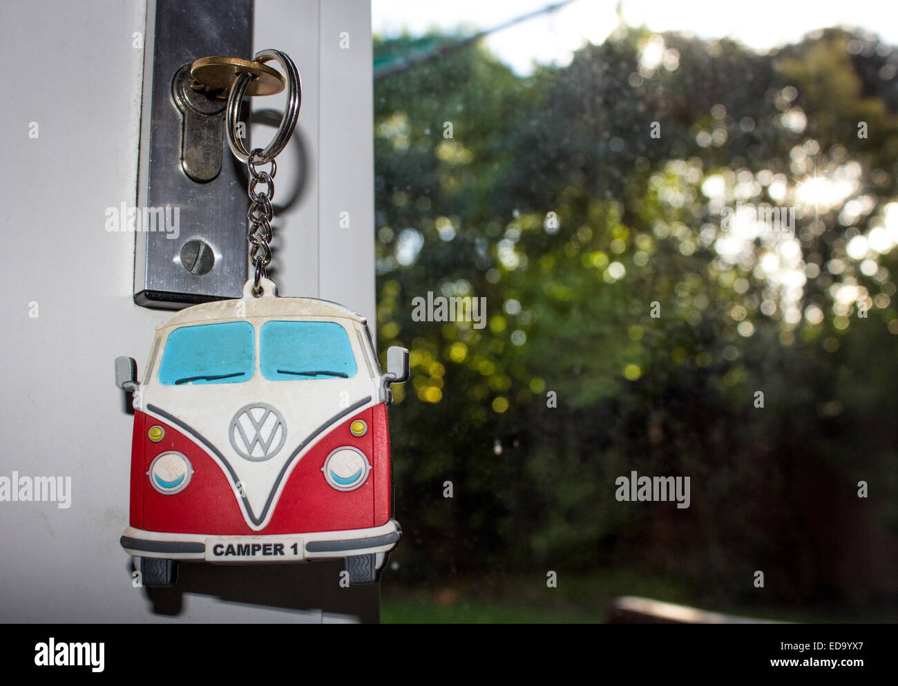 Unusual camper van key chain on a key in a door with view out of the ...