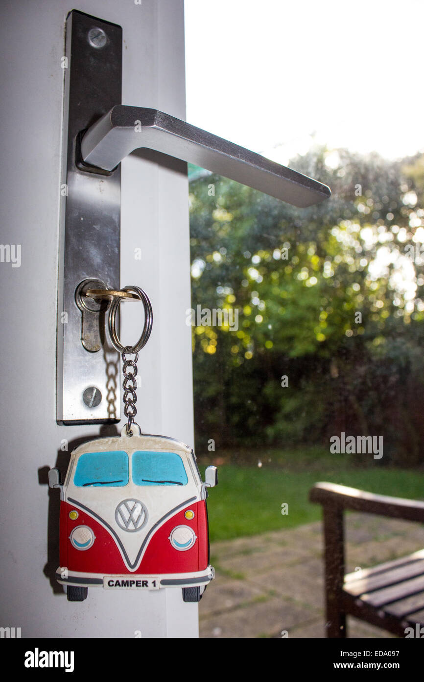 Unusual camper van key chain on a key in a door with view out of the ...