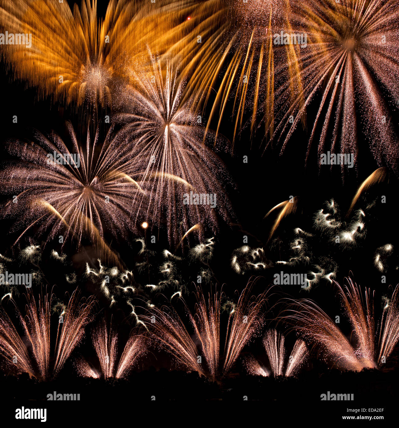 Golden orange red amazing fireworks explosion background in night time ...