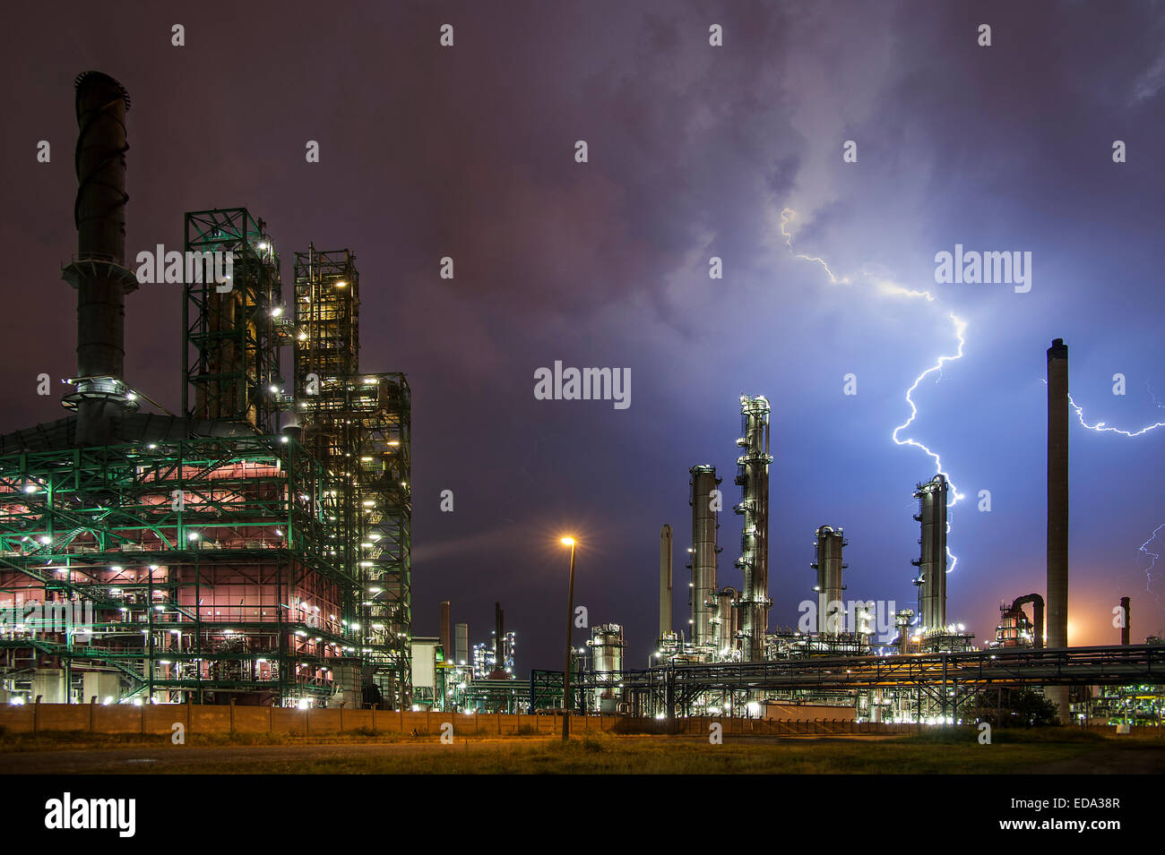 Lightning bolts striking oil refinery at industrial estate during heavy ...