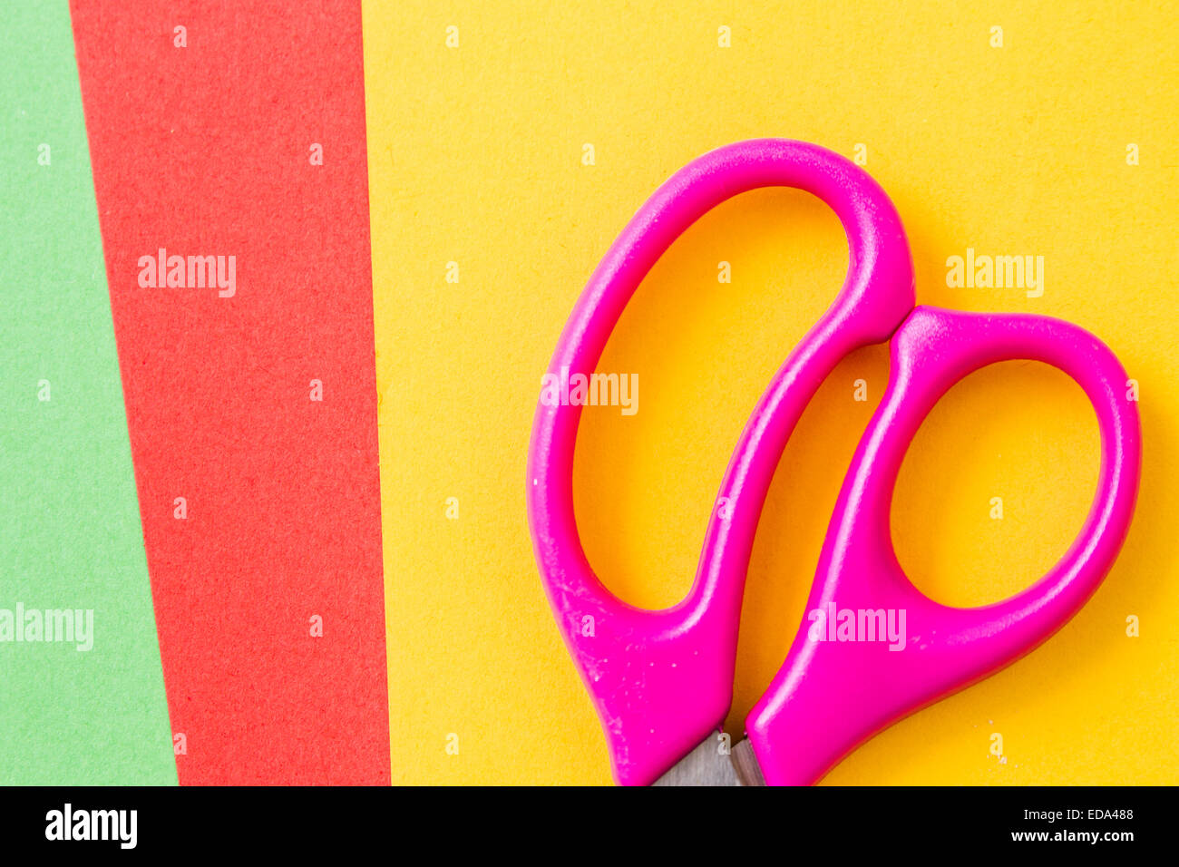 Pink scissors and colorful handicraft papers, top view Stock Photo - Alamy