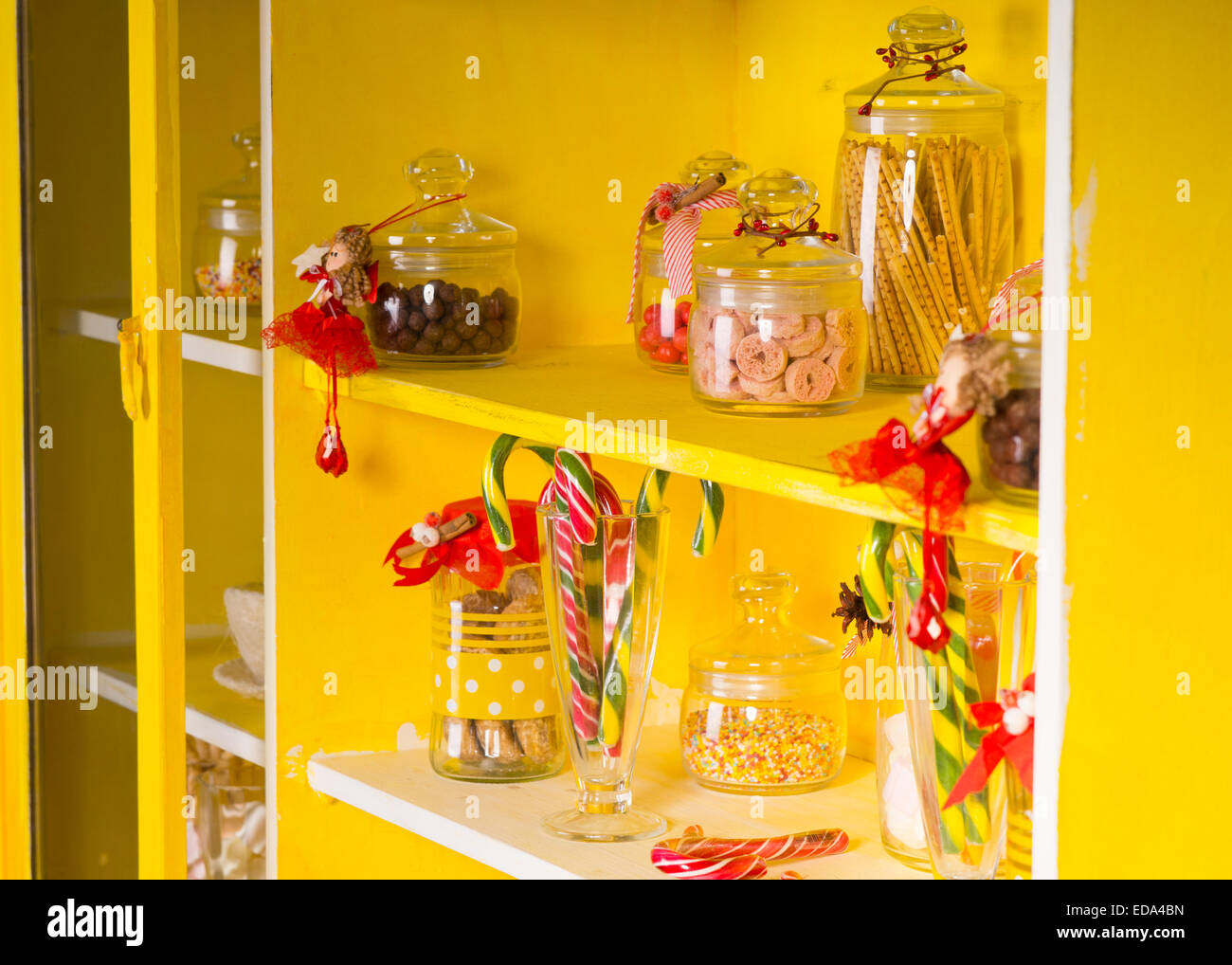 Assorted Sweet Candies on Transparent Glass Jars at Yellow Shelves ...