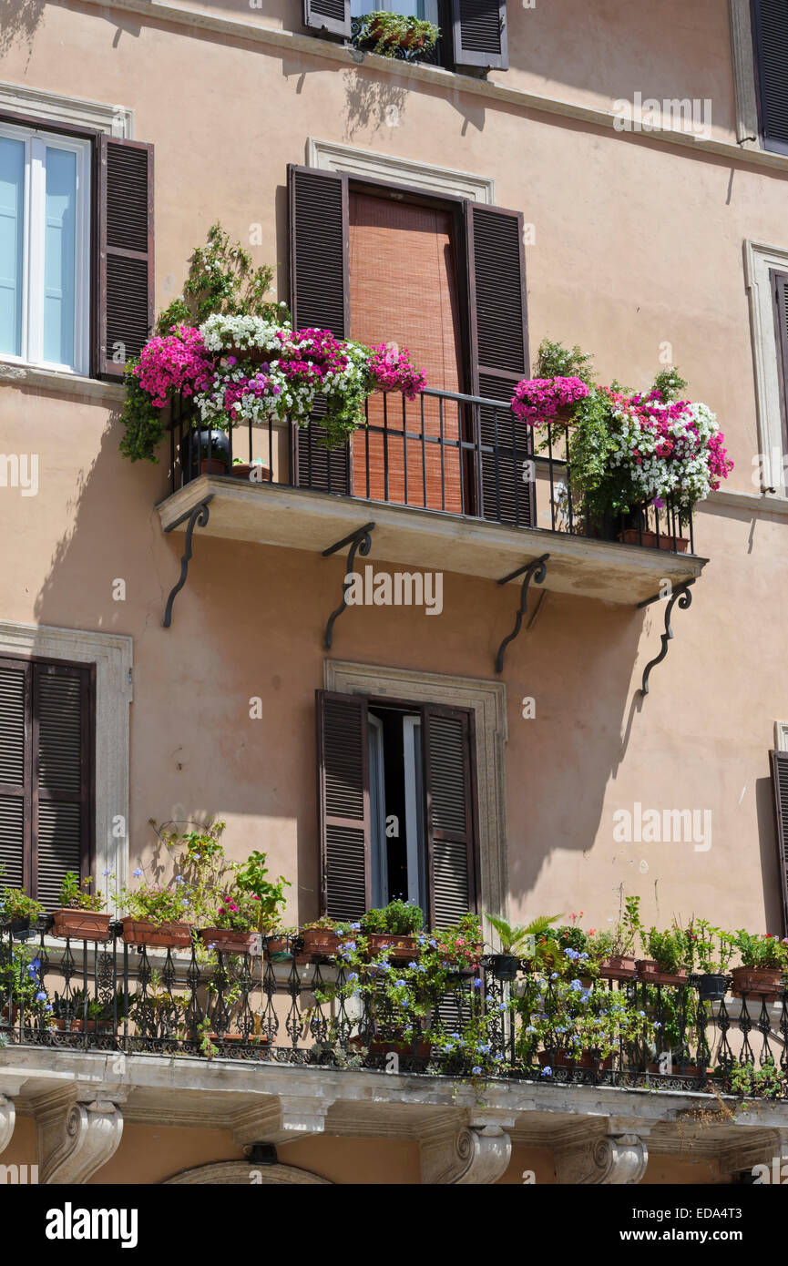 A traditional facade of an Italian building with fresh flowers on the ...