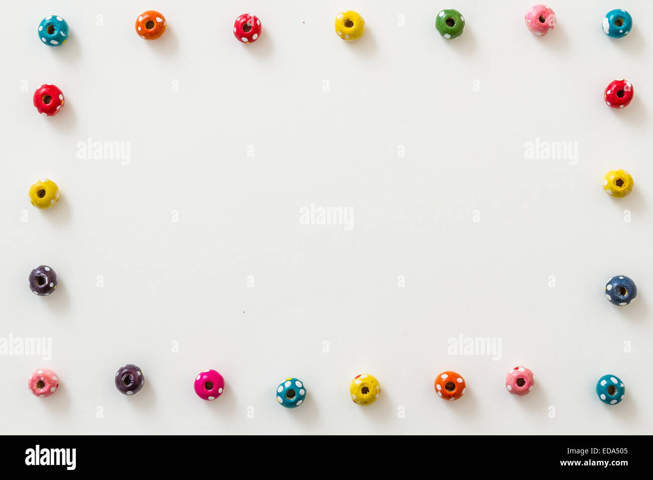 Multi colored beads on white background with copy space Stock Photo - Alamy