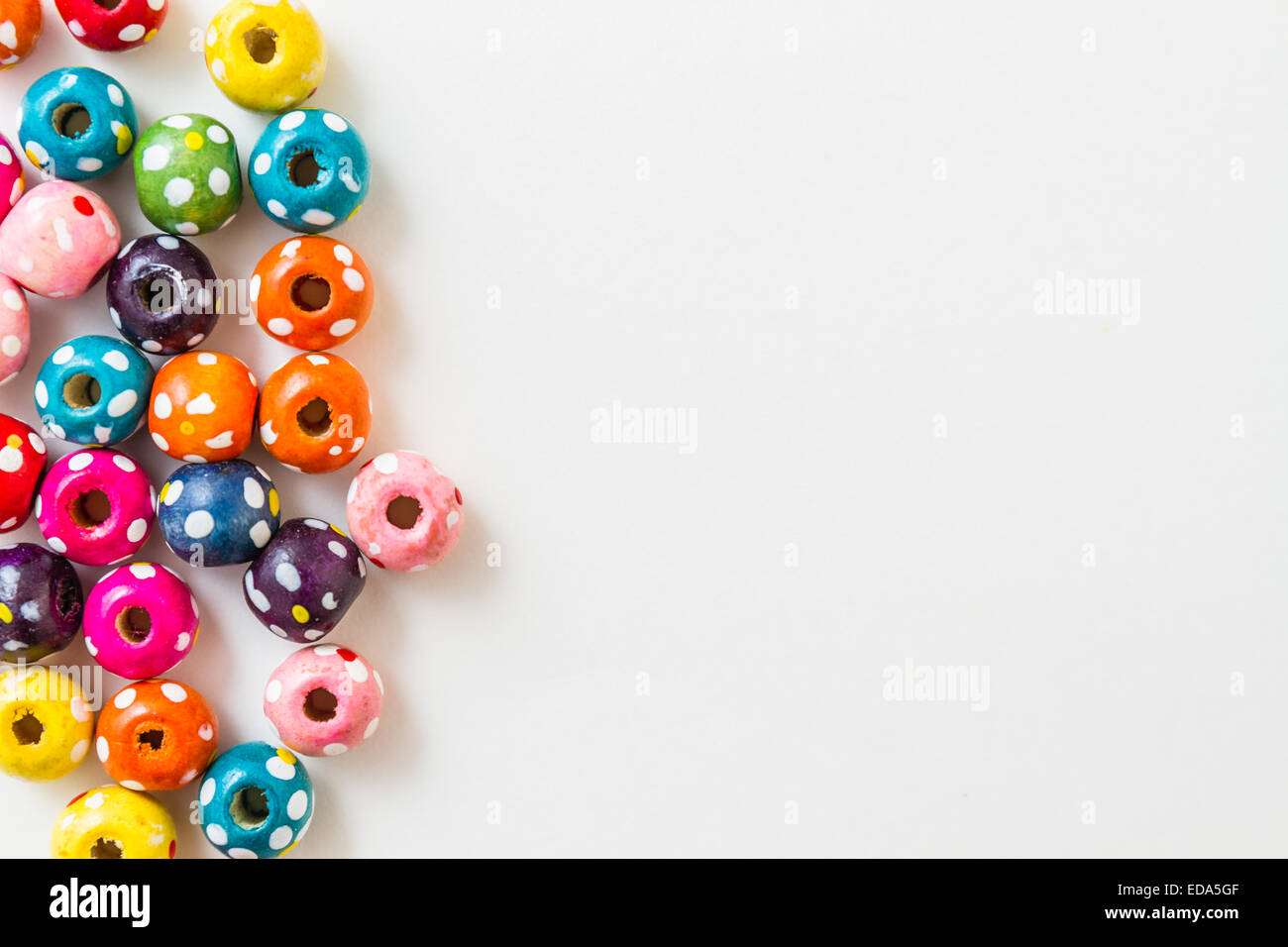 Multi colored beads heap on white background with copy space Stock ...
