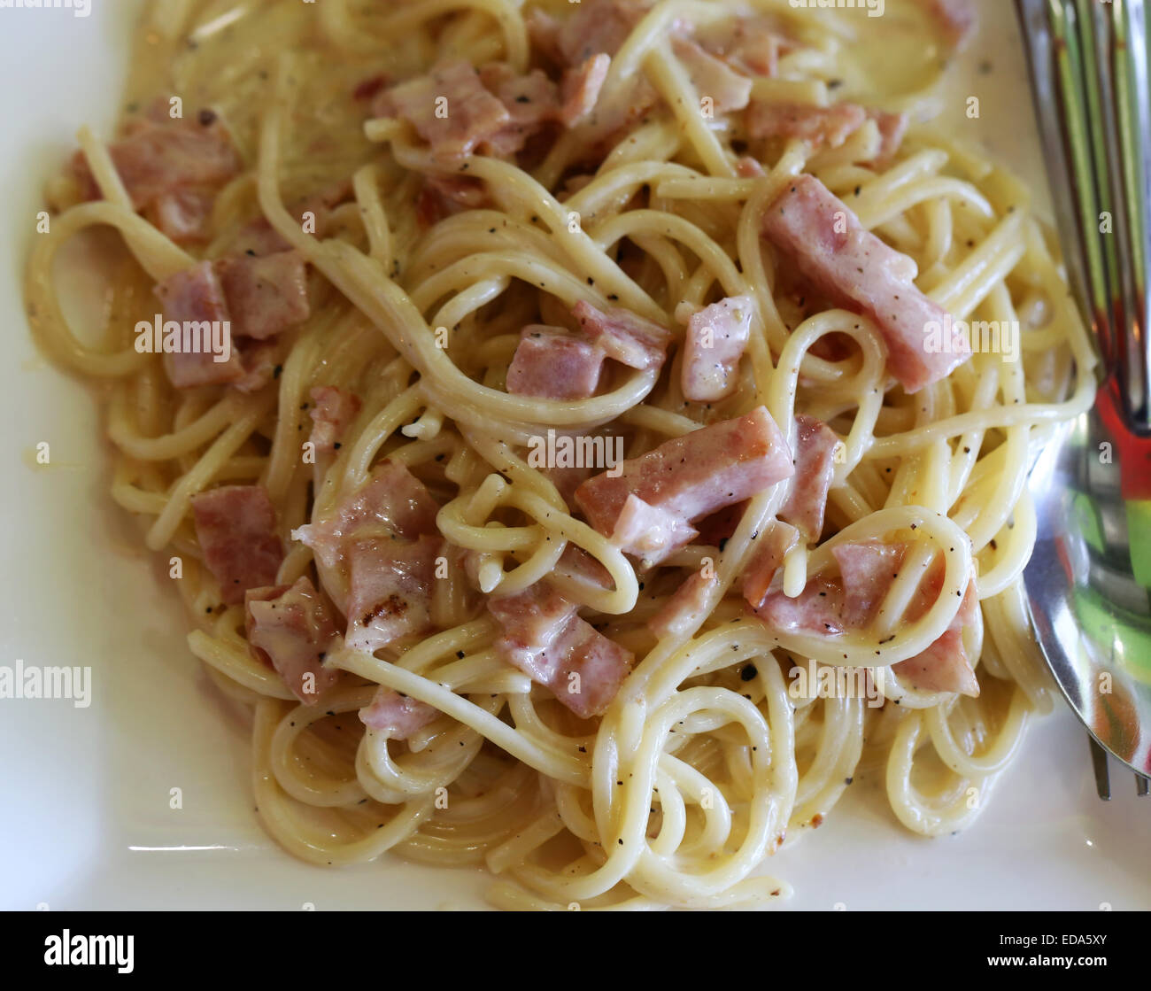 Spaghetti with ham photographed closeup on a white plate Stock Photo ...