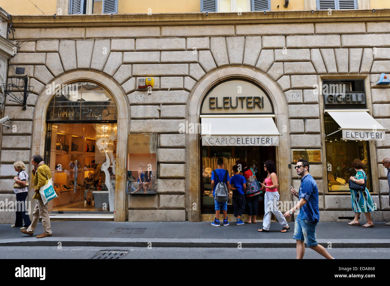 Tourists exploring the famous Via Condotti street with designer and ...