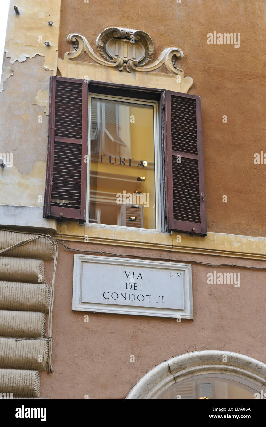 An open window with wooden shutter above the famous Via dei Condotti ...