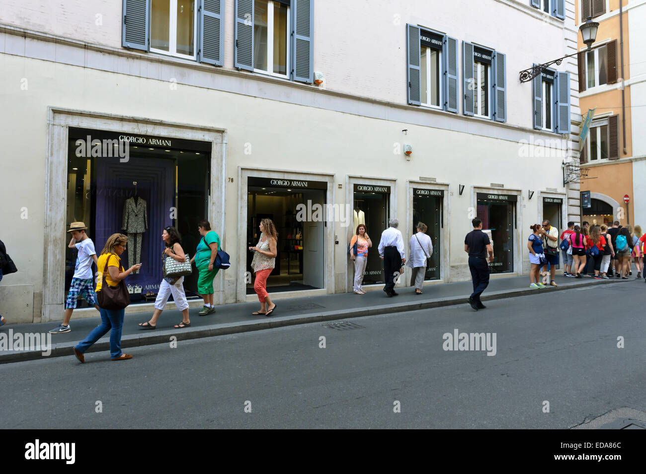Tourists exploring the famous Via Condotti street with designer and ...
