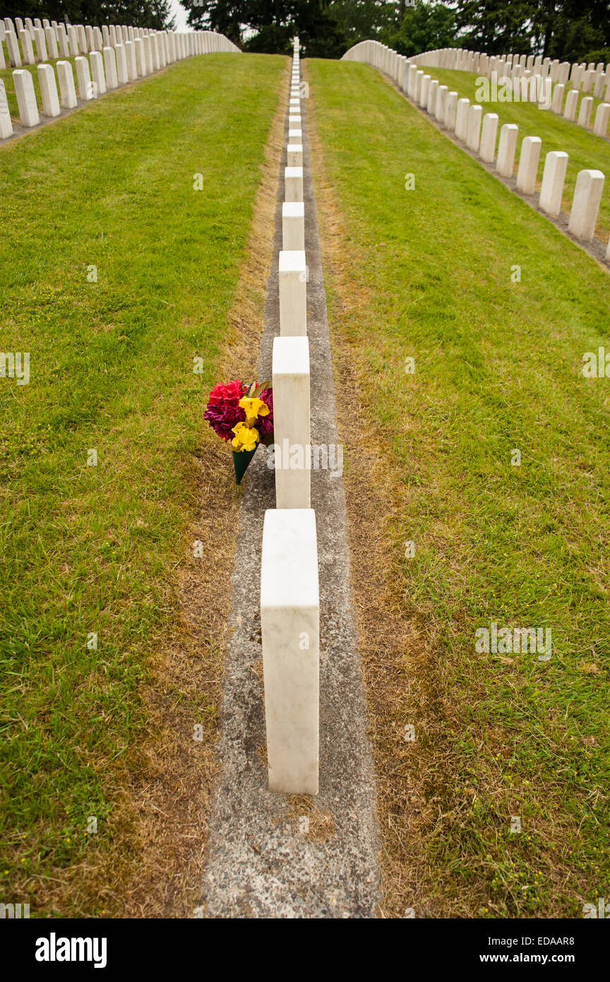 Head stones at cemetery on a Spring afternoon with grave stones in rows ...