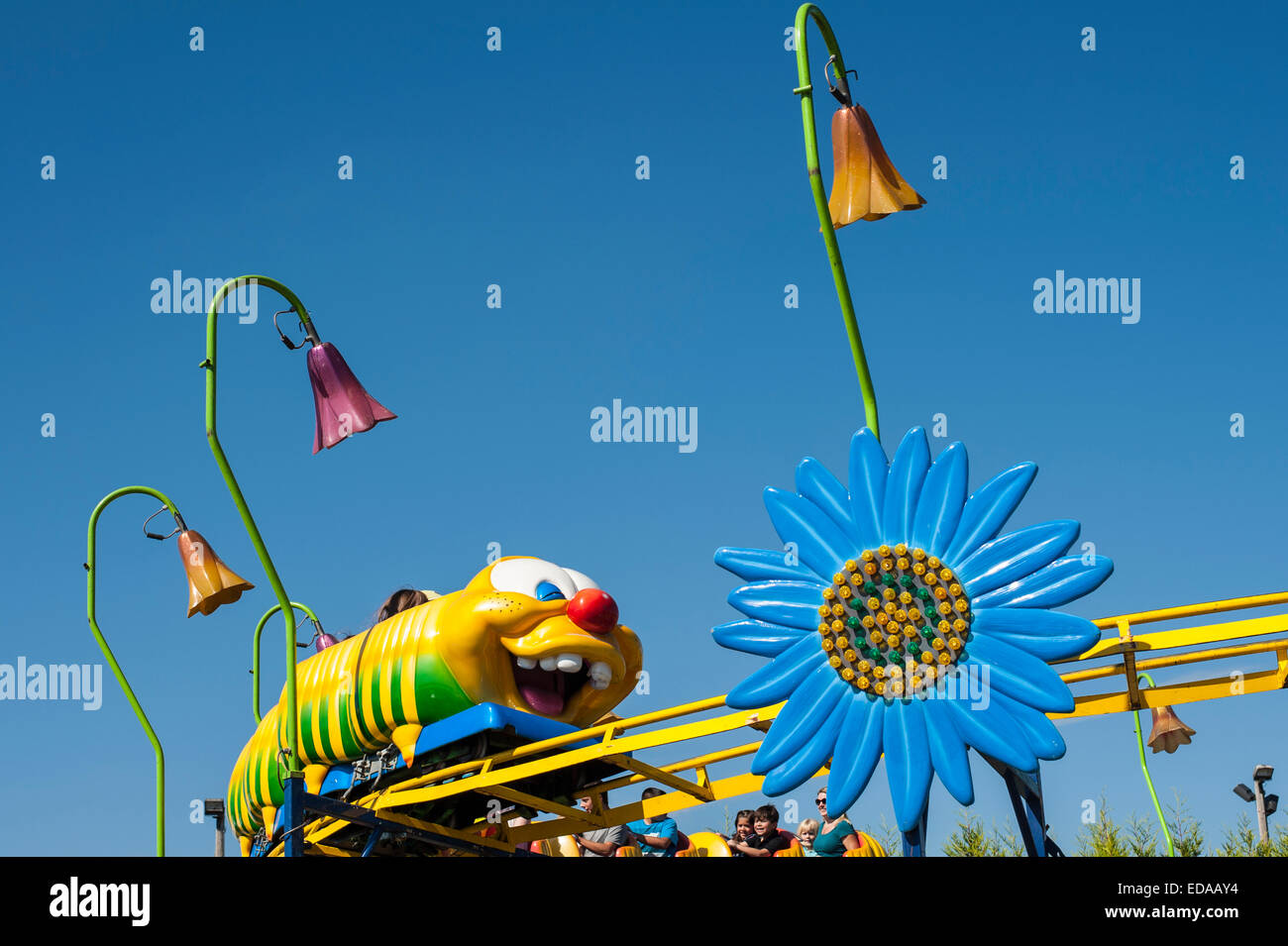 Fair with kiddie roller coaster ride Stock Photo - Alamy