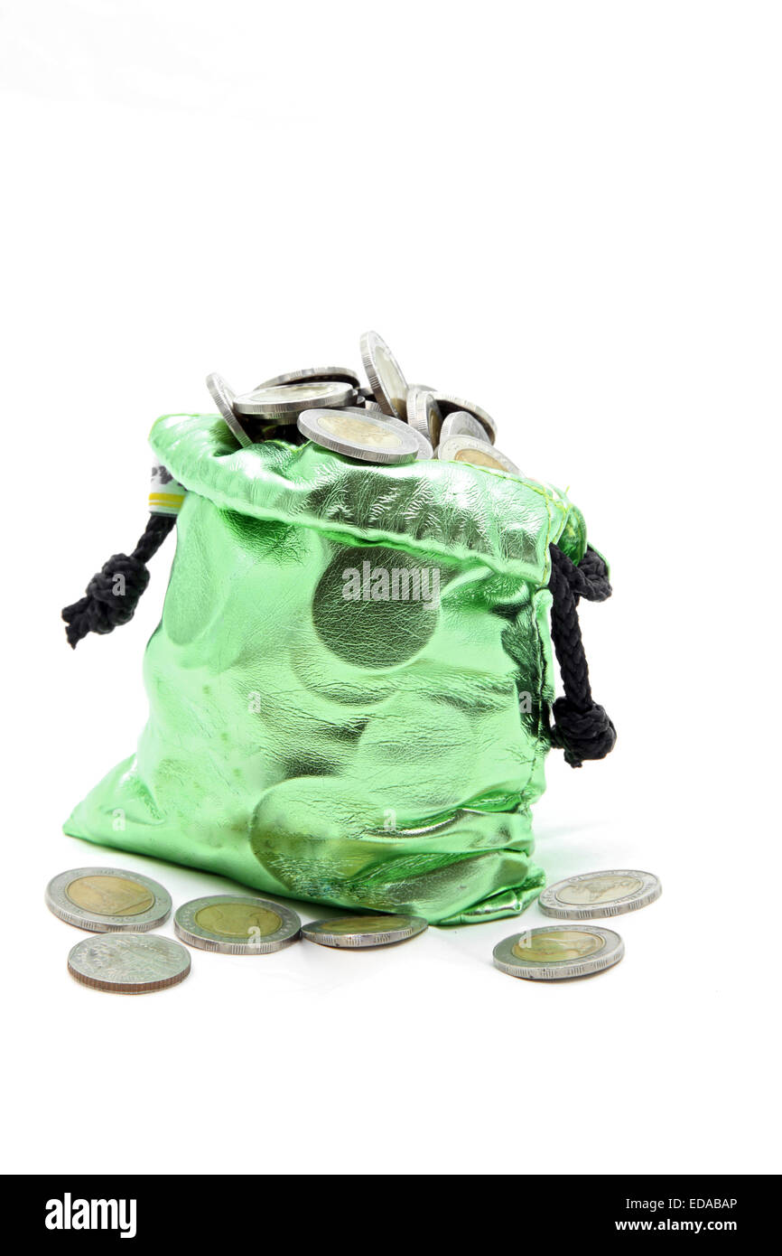 full coins spilling out from green money bag or purse isolated on white ...