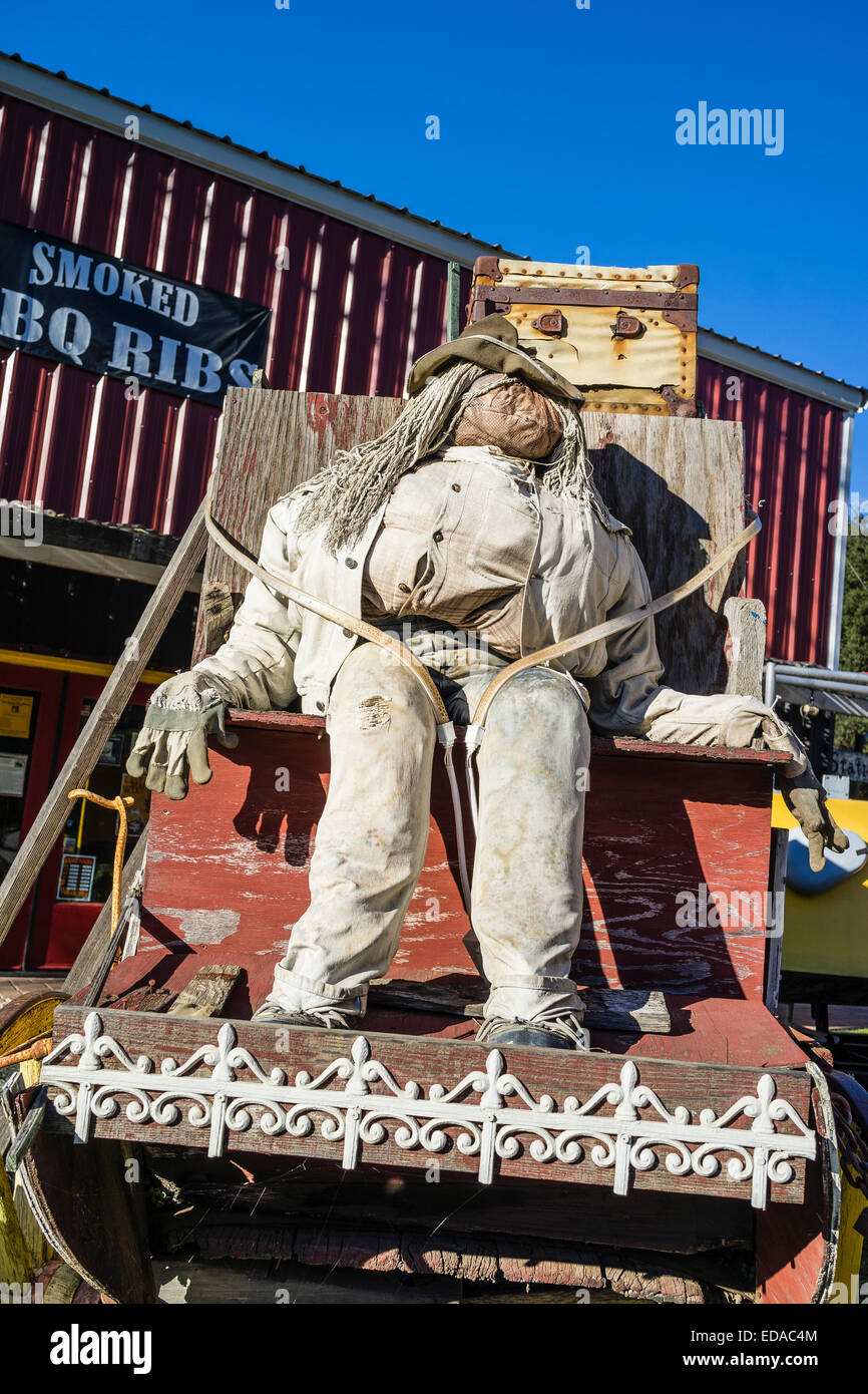 Dummy stage coach driver seated on the driver's seat of an old stage ...