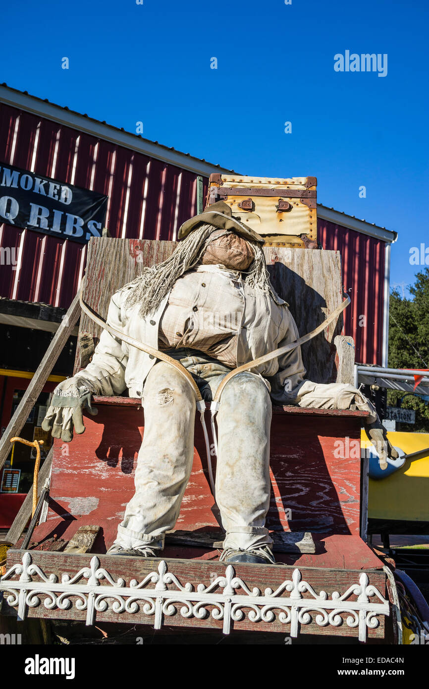 Dummy stage coach driver seated on the driver's seat of an old stage ...