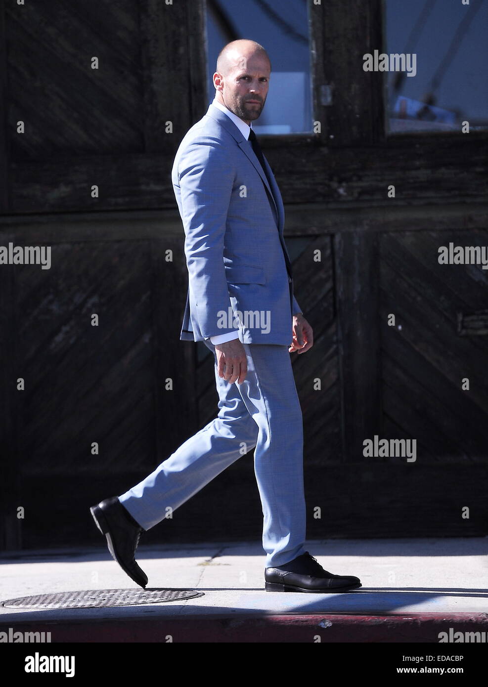 Actor Jason Statham puts on a gray suit at a photoshoot in downtown L.A ...