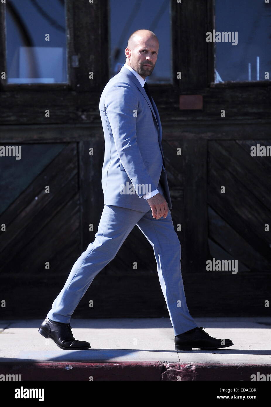 Actor Jason Statham puts on a gray suit at a photoshoot in downtown L.A ...