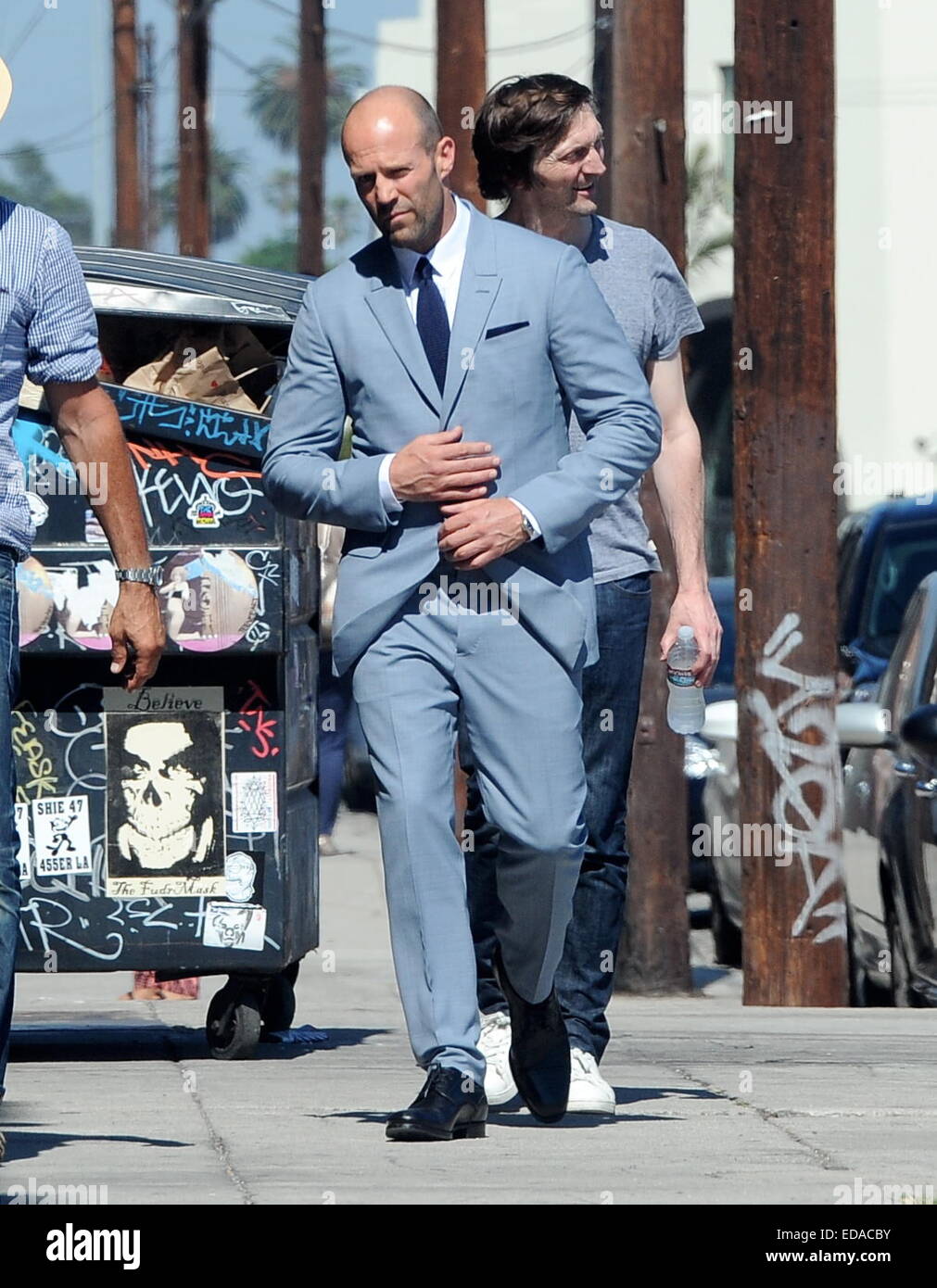 Actor Jason Statham puts on a gray suit at a photoshoot in downtown L.A ...