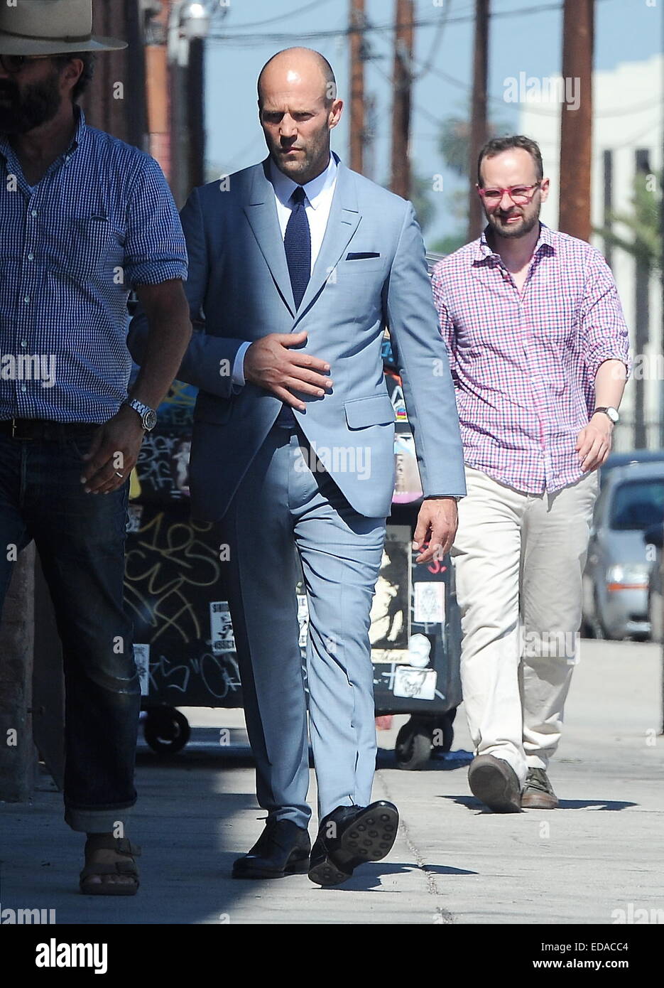 Actor Jason Statham puts on a gray suit at a photoshoot in downtown L.A ...