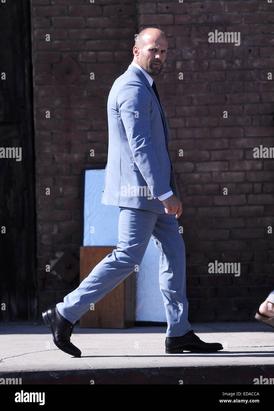 Actor Jason Statham puts on a gray suit at a photoshoot in downtown L.A ...