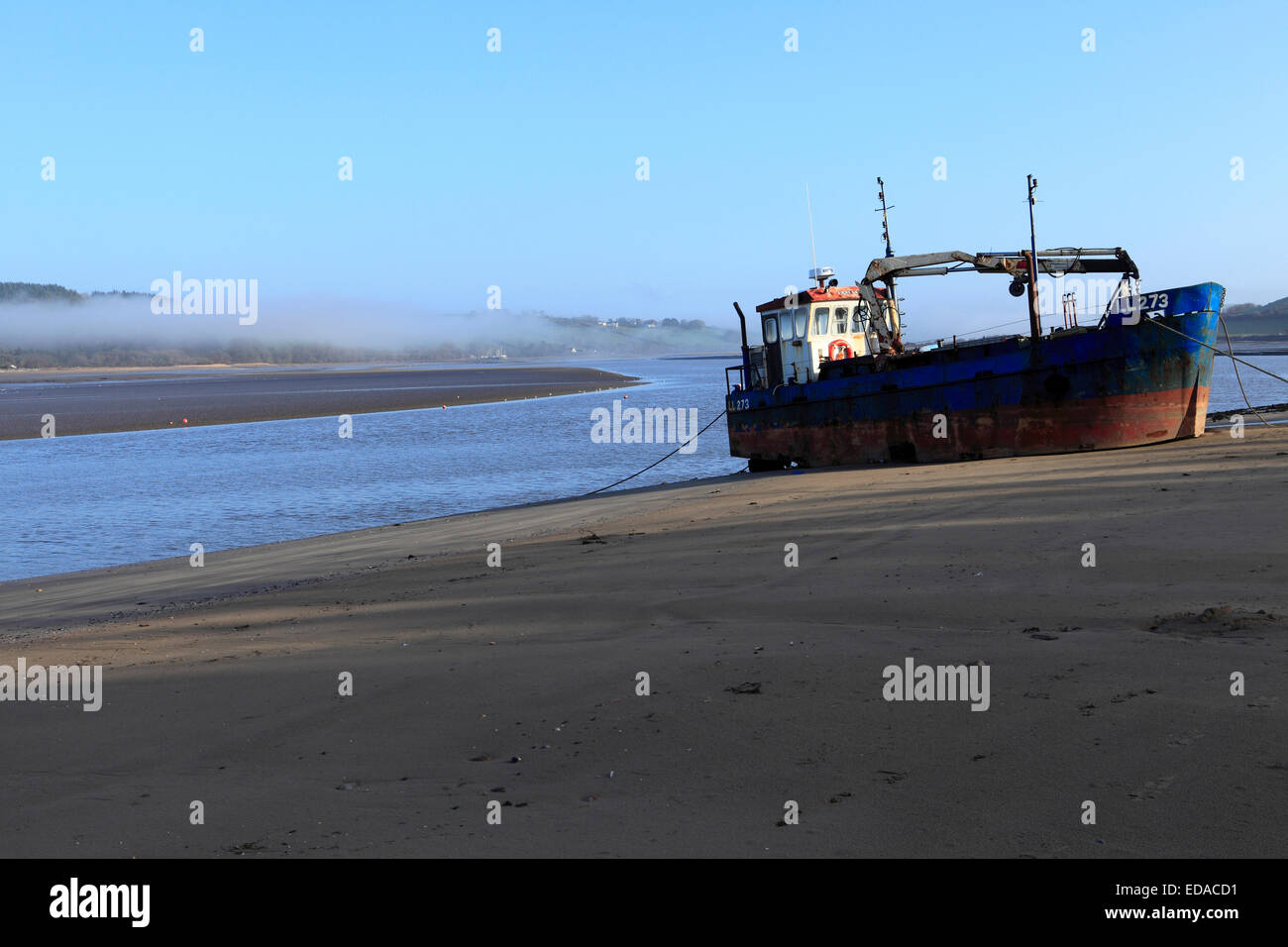 Boat on shore, in early morning light, Ferryside Carmarthen, Wales ...