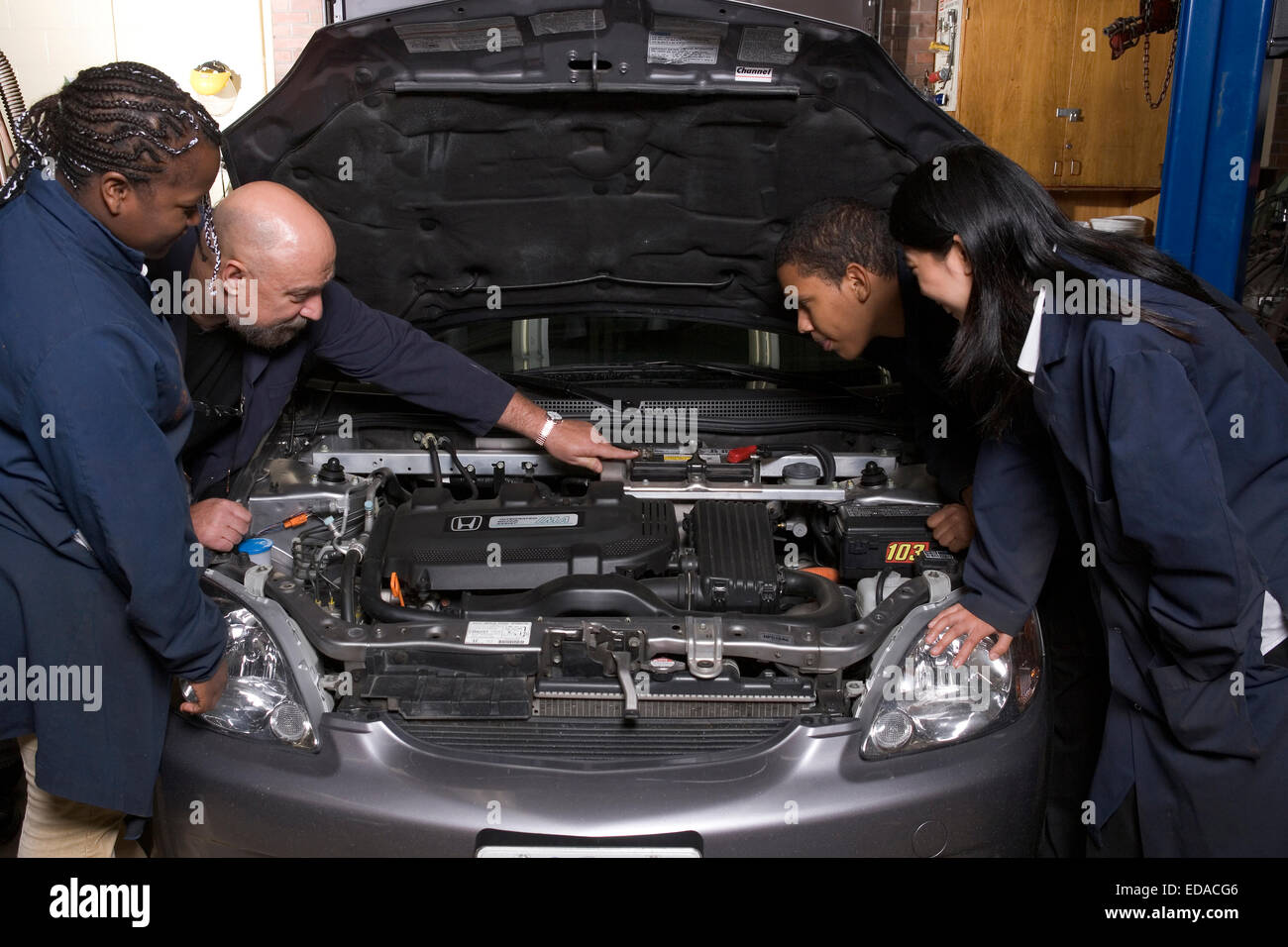 Auto mechanic teacher with students Stock Photo - Alamy