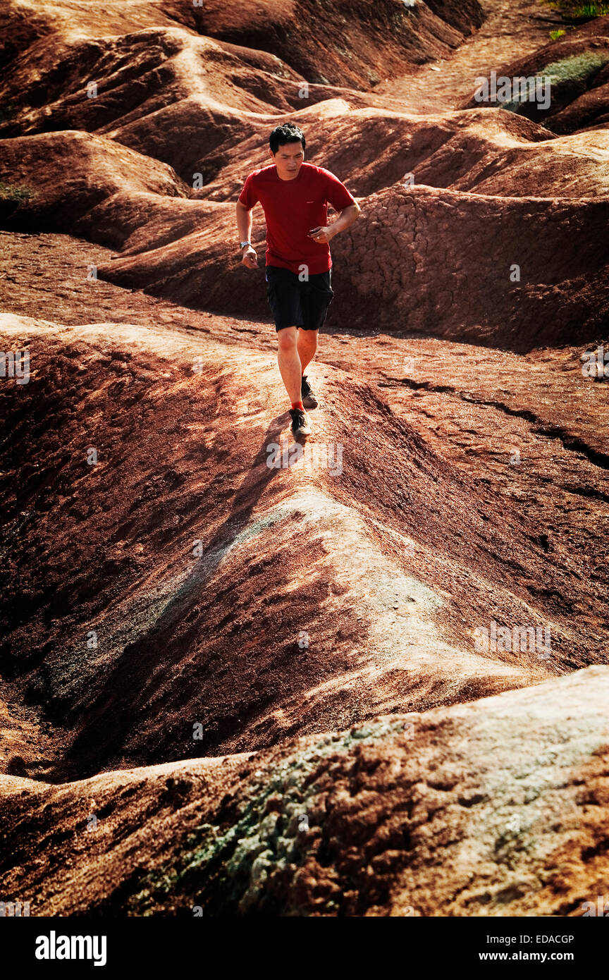 Man running in the badlands Stock Photo - Alamy