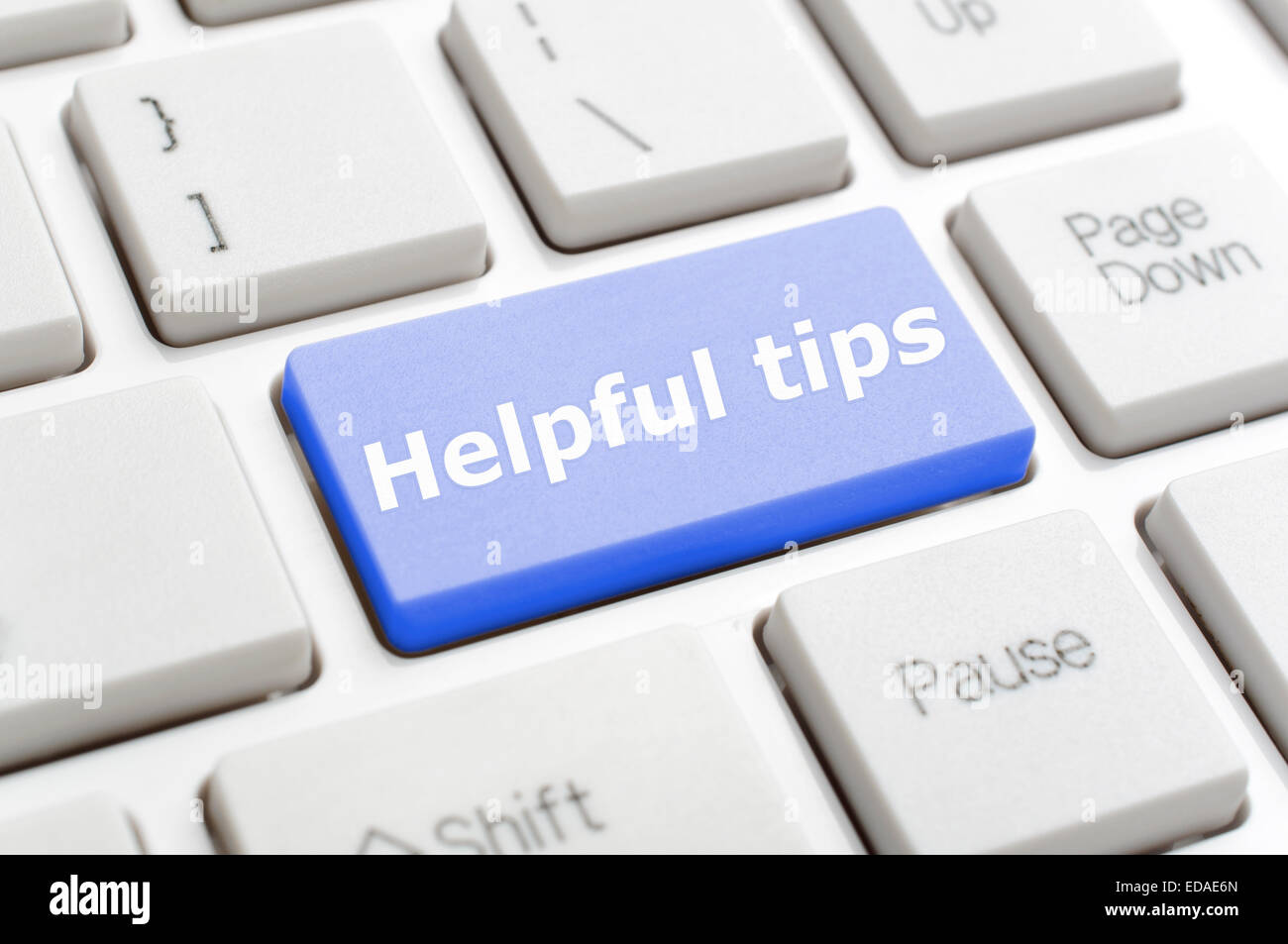 Blue helpful tips key on keyboard Stock Photo - Alamy