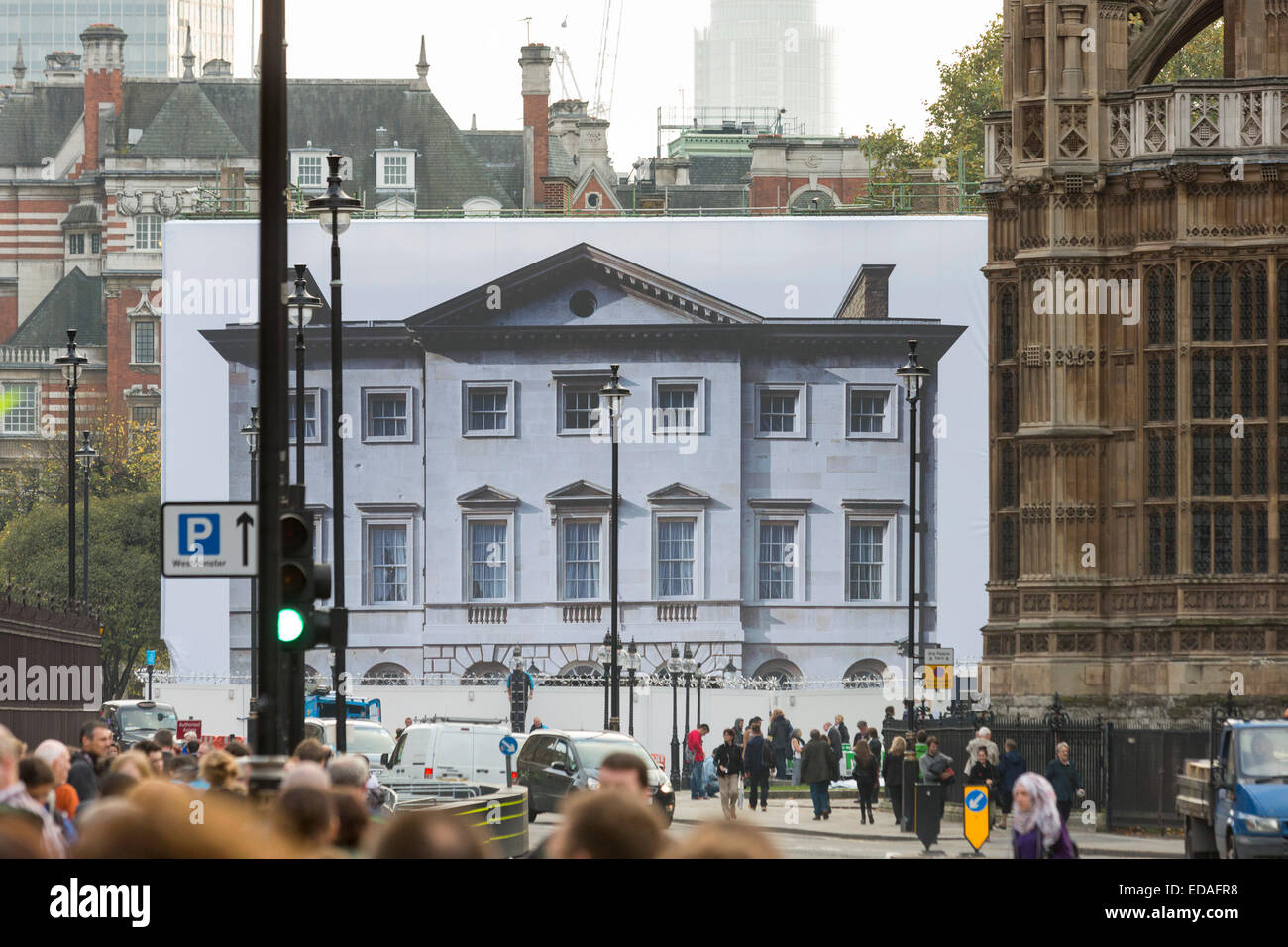 A building is covered with a scaffolding with a printed scrim in ...