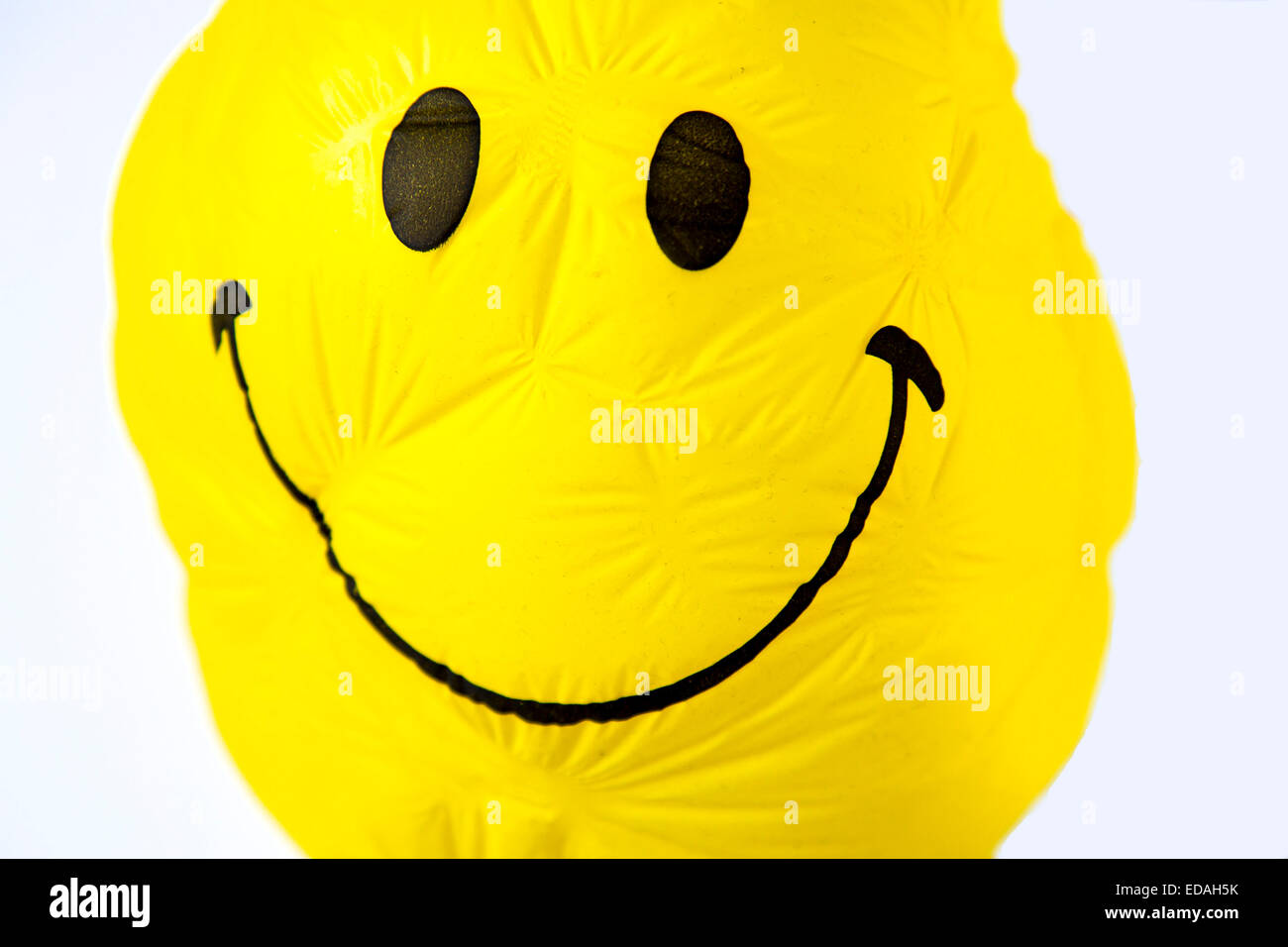 old Balloon, yellow, shriveled with friendly smiley face, sunken ...