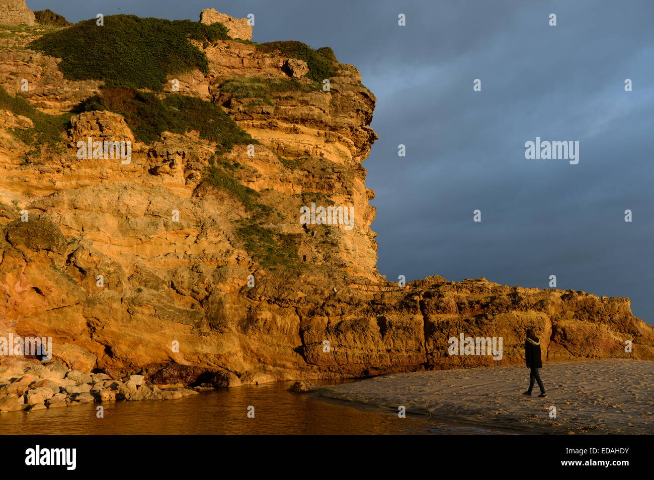yellow colored cliffs at Figuiera beach glow in the setting sun Stock ...