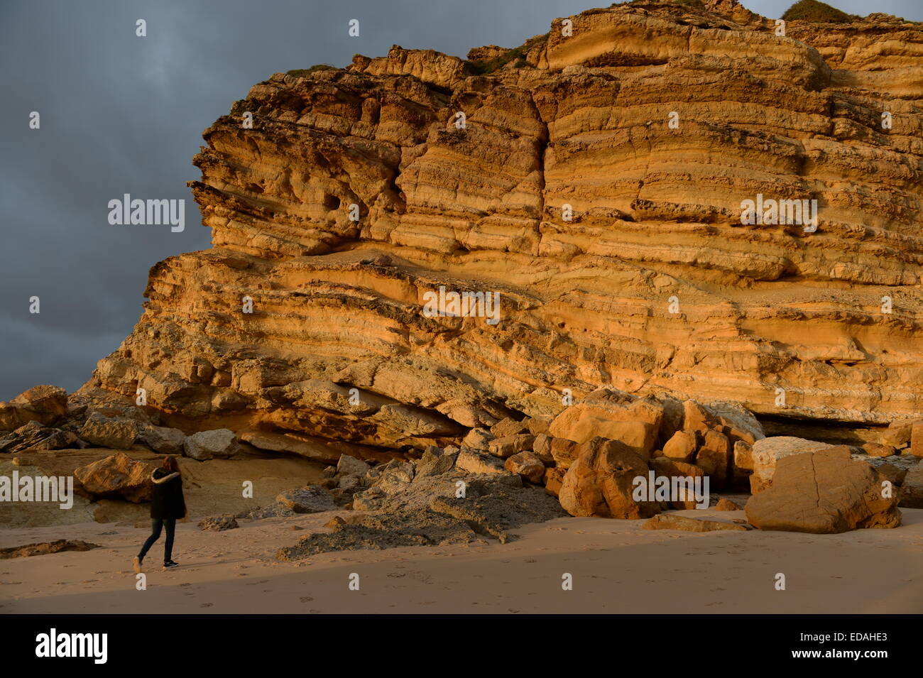 yellow colored cliffs at Figuiera beach glow in the setting sun Stock ...