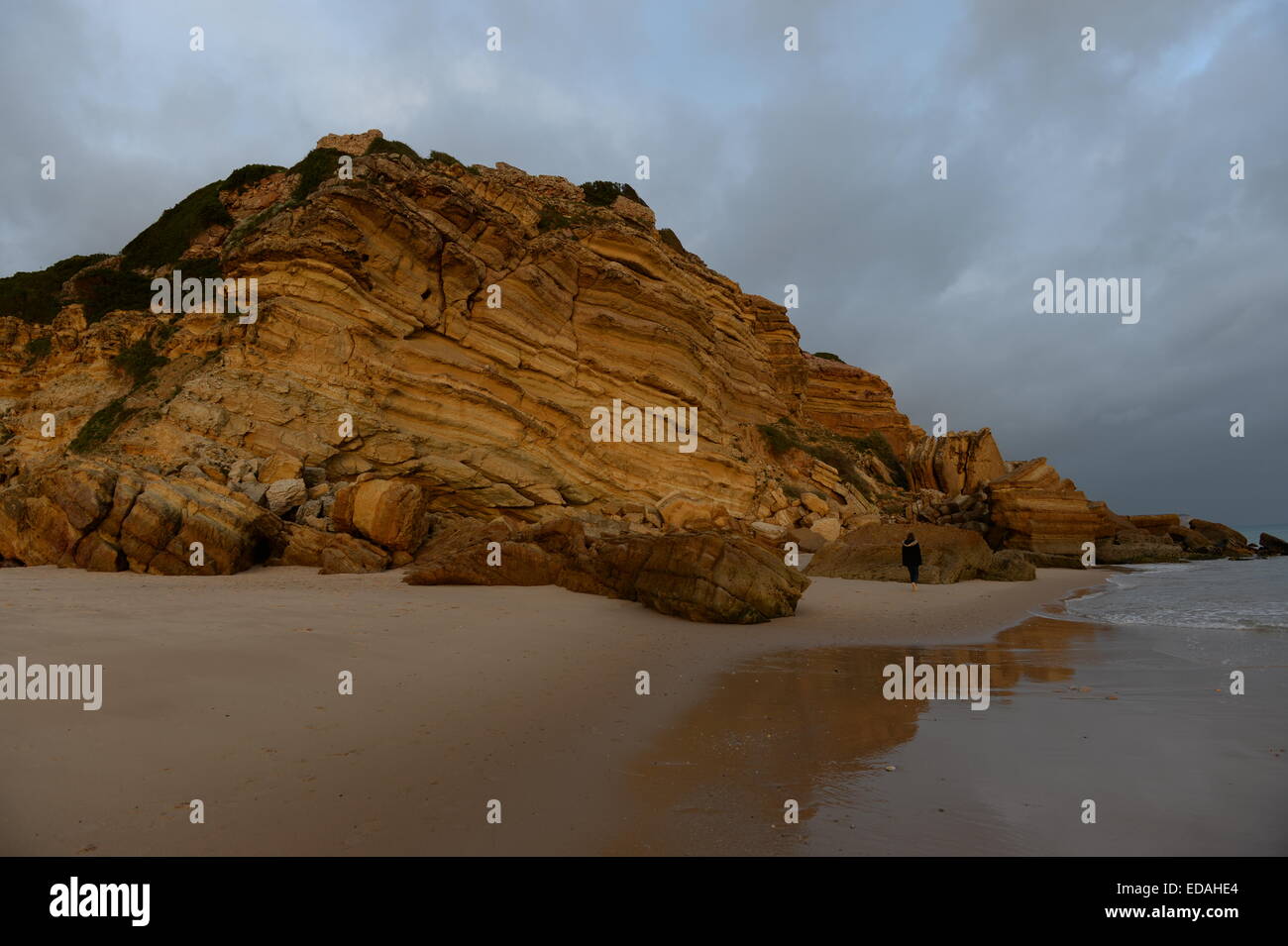 yellow colored cliffs at Figuiera beach Stock Photo - Alamy