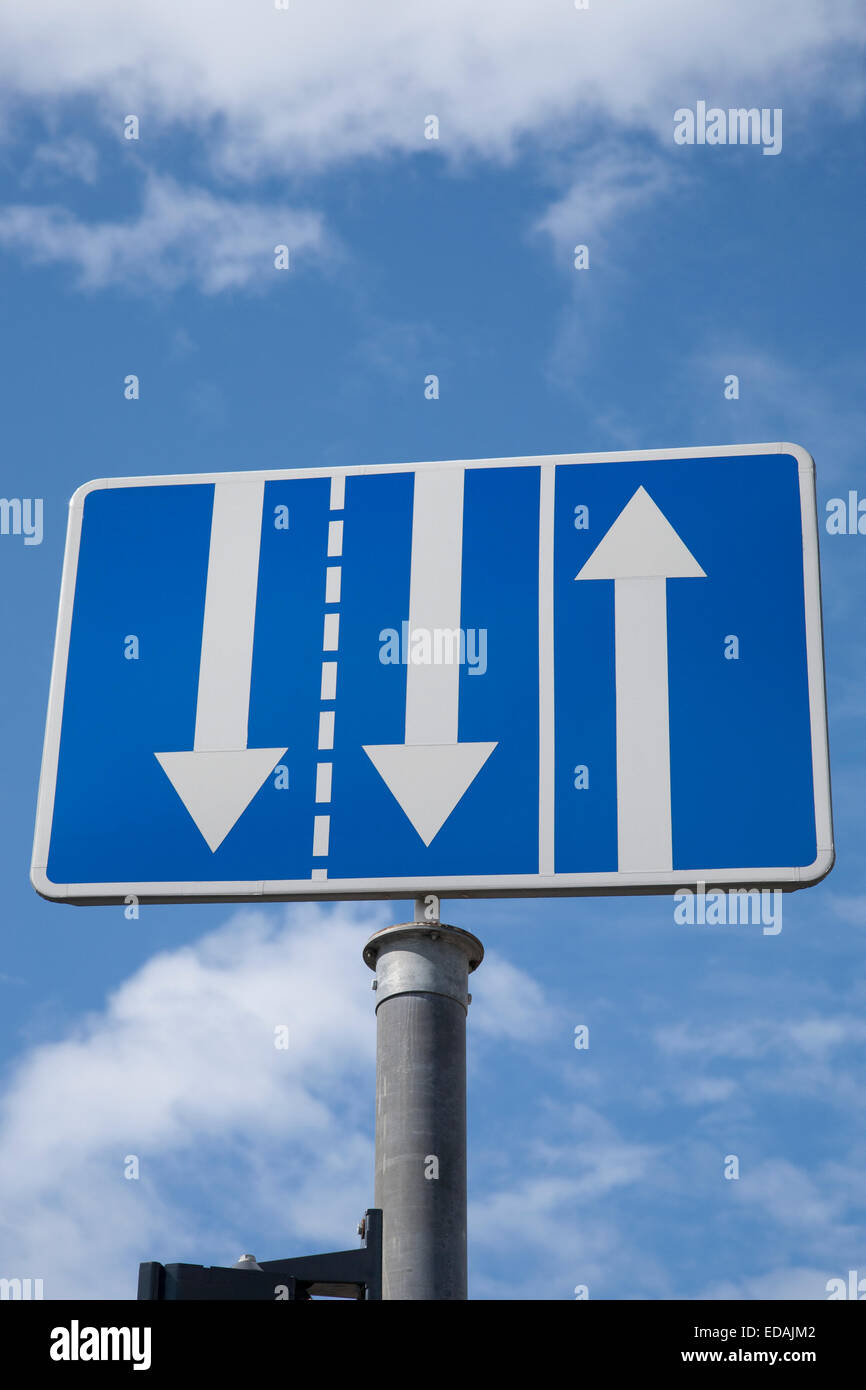 Blue and White Triple Arrow Sign against Blue Sky Background Stock ...