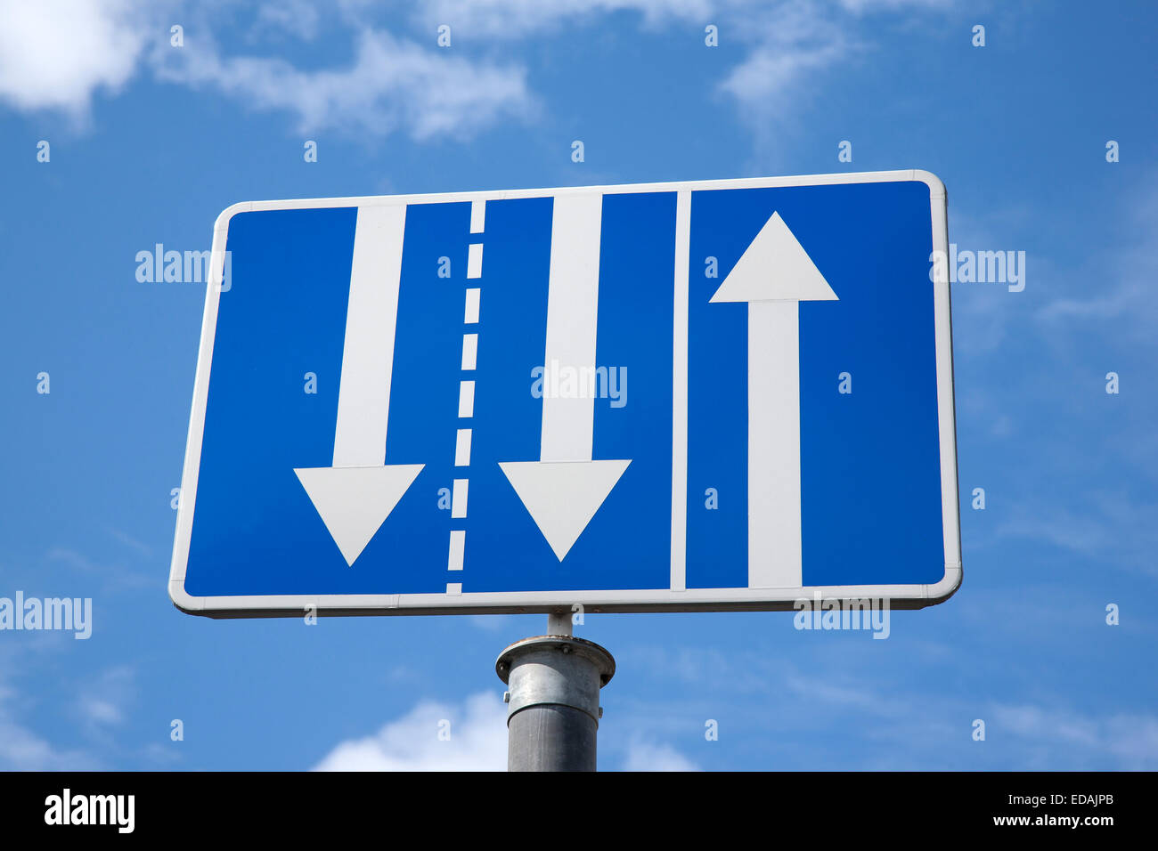 Blue and White Triple Arrow Sign against Blue Sky Background Stock ...