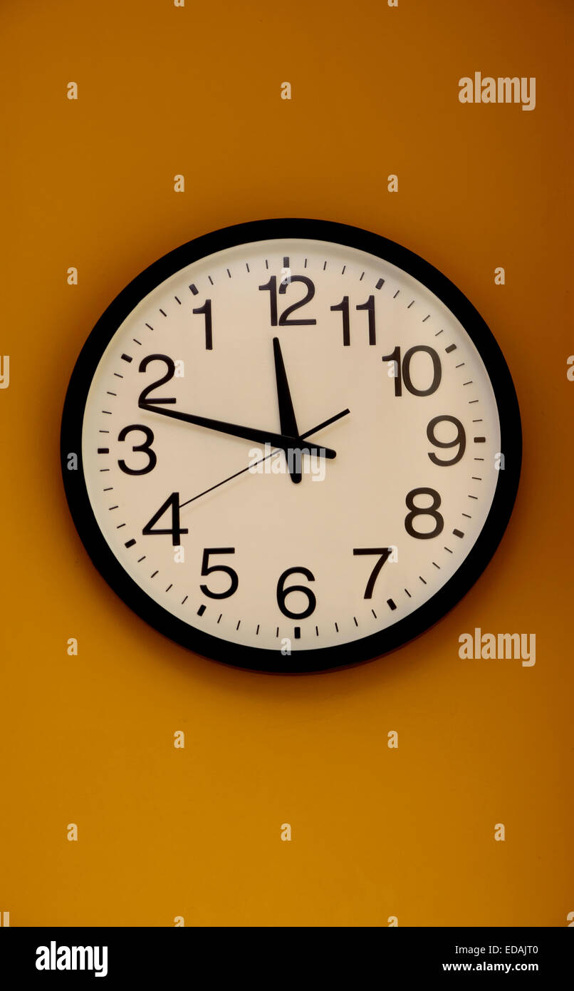 Wall clock with the order of the numbers inverted Stock Photo - Alamy