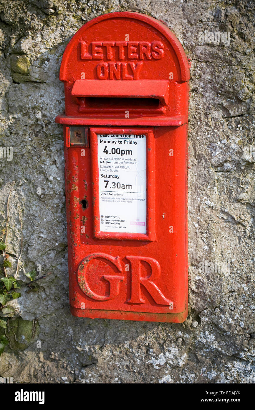 Red post box in stone wall Stock Photo - Alamy