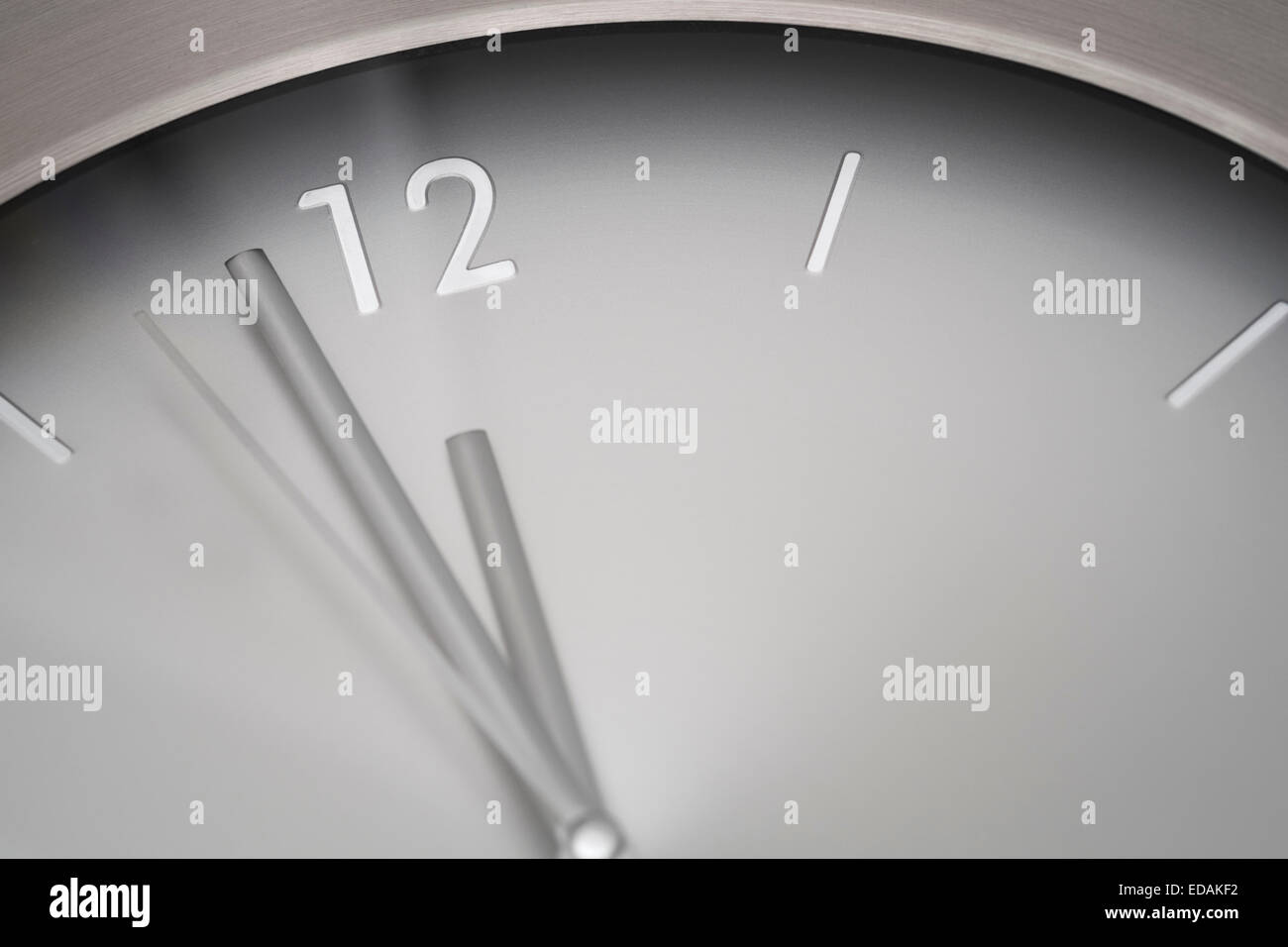 Silver clock face with hands approaching midday or midnight Stock Photo ...