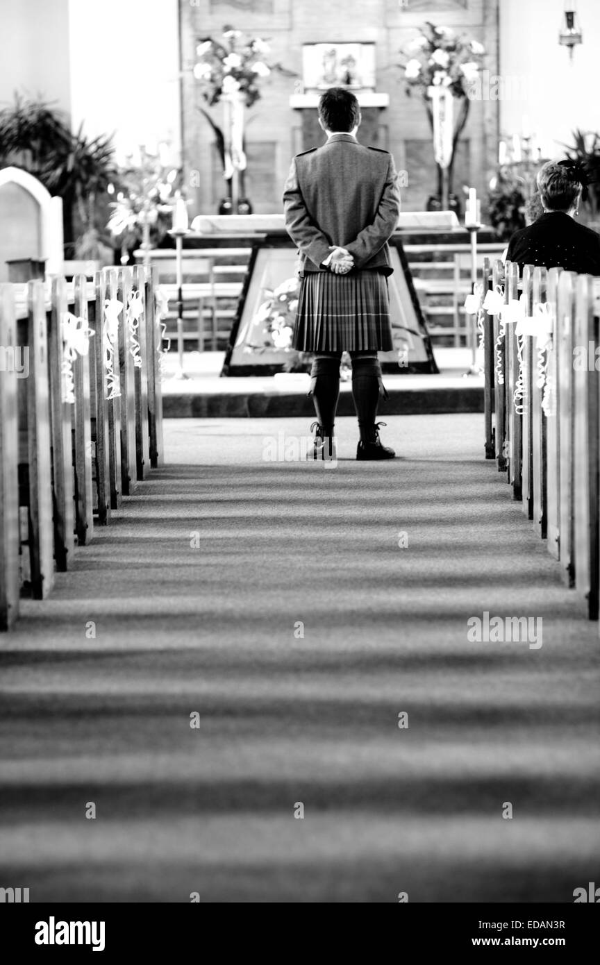 Groom awaiting his bride at church alter Stock Photo - Alamy