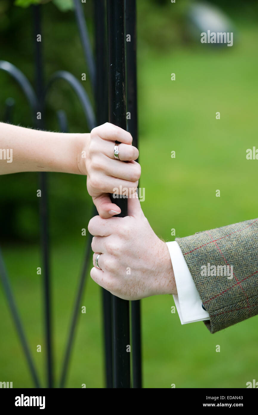 married couples hands with wedding rings holding a pole Stock Photo - Alamy