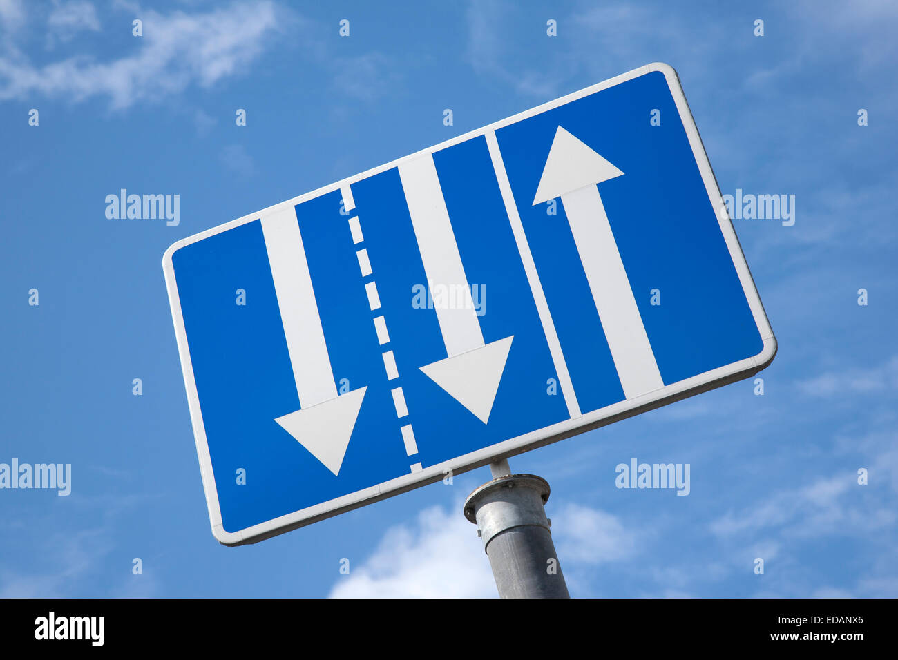 Blue and White Triple Arrow Sign against Blue Sky Background Stock ...