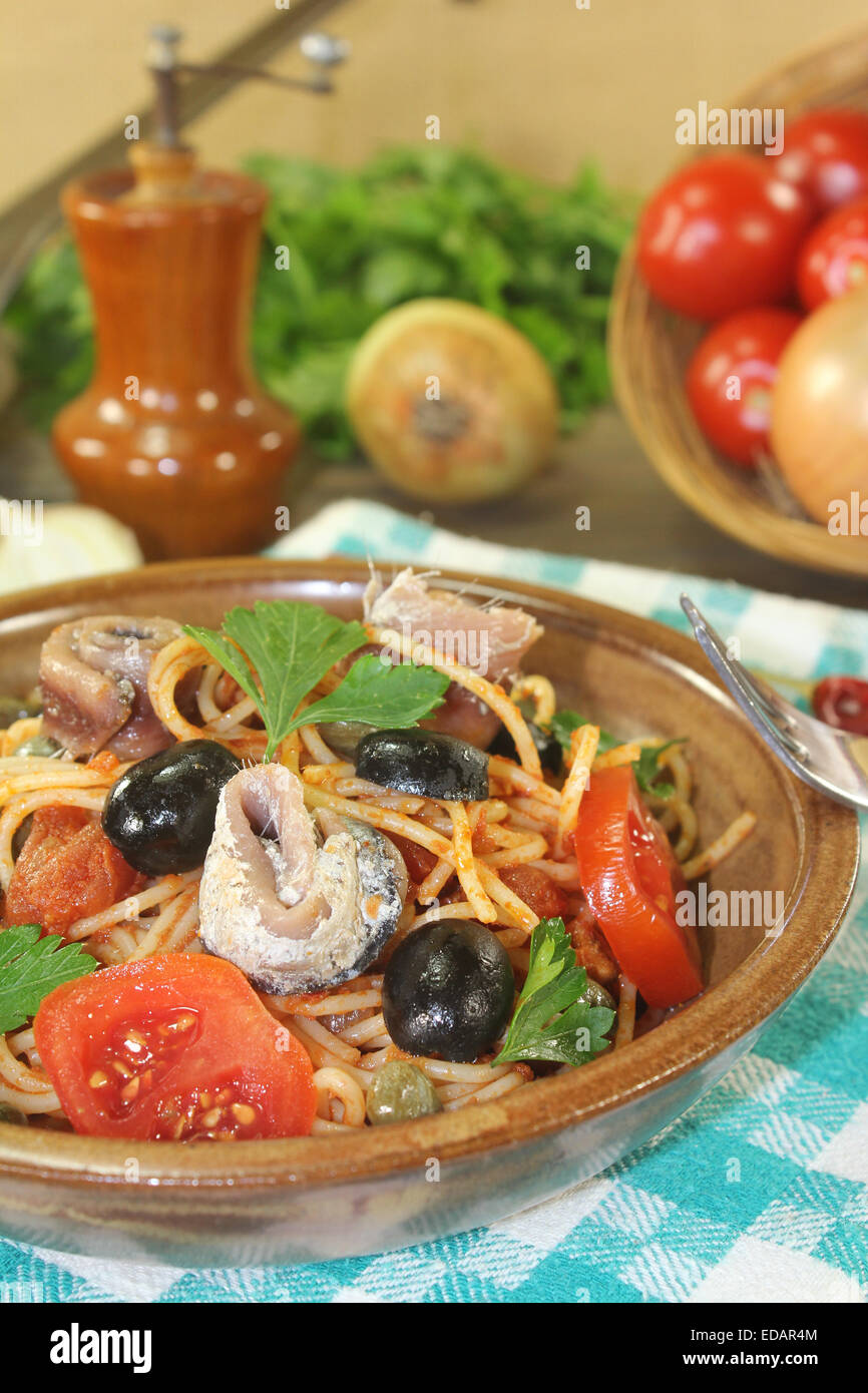 Spaghetti alla puttanesca with anchovy and tomatoes on a napkin Stock ...