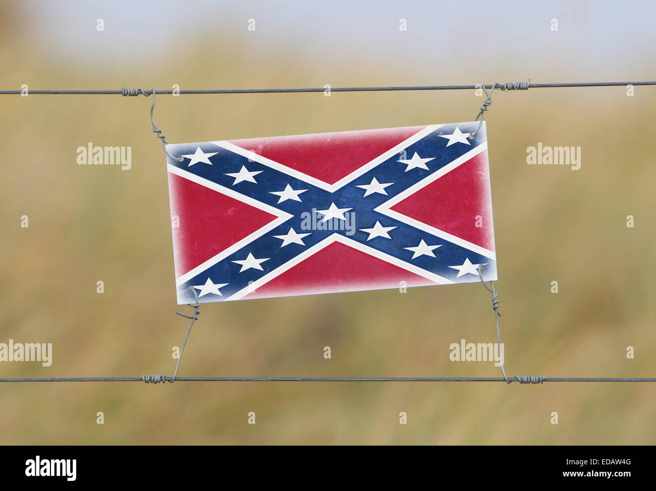 Border fence - Old plastic sign with a flag - Confederate flag Stock ...