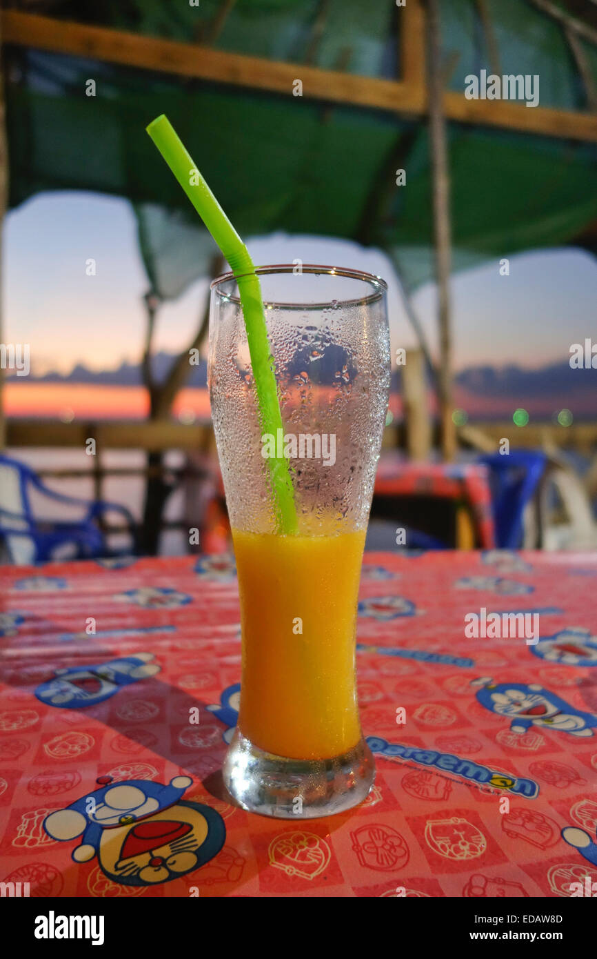 Fresh Mango juice in restaurant bar with sunset behind. Thailand. Asia ...