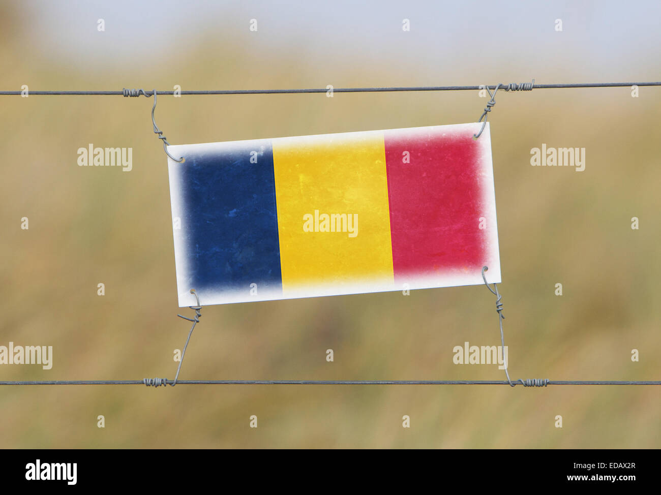Border fence - Old plastic sign with a flag - Romania Stock Photo - Alamy