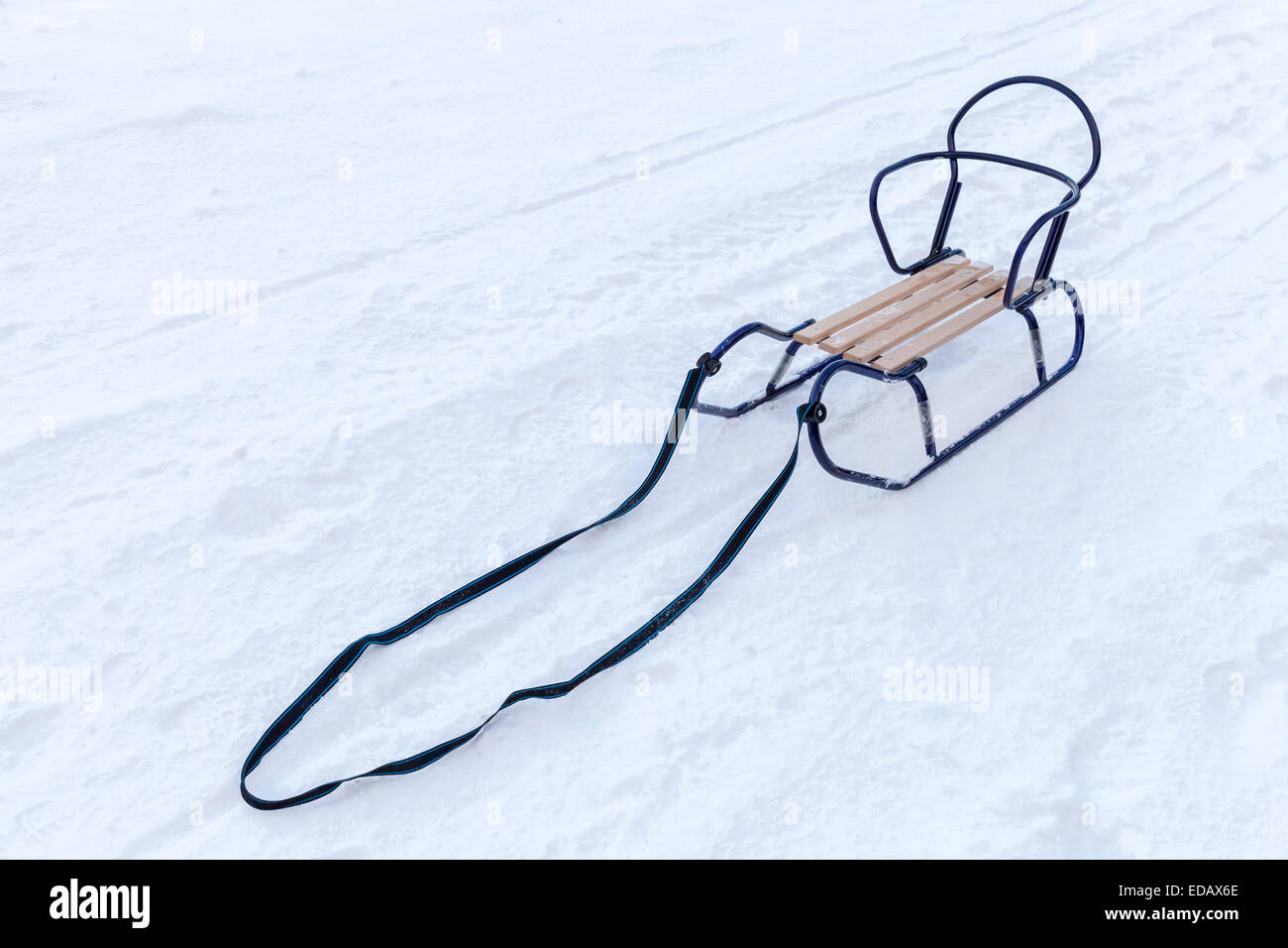 Small metal sled with wooden seat standing in the snow Stock Photo - Alamy