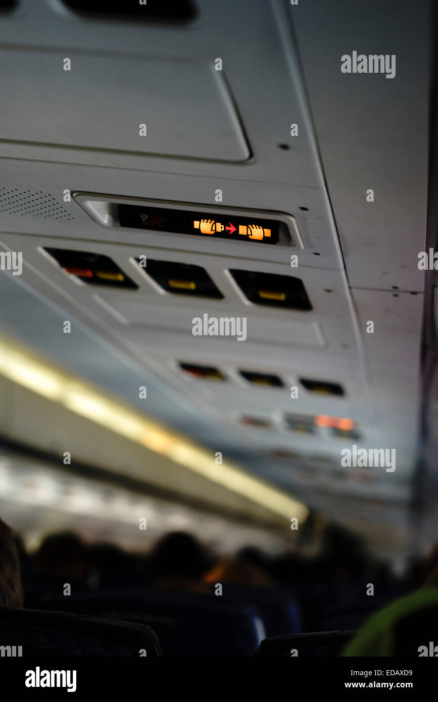 Airplane illuminated fasten seat belt sign Stock Photo - Alamy