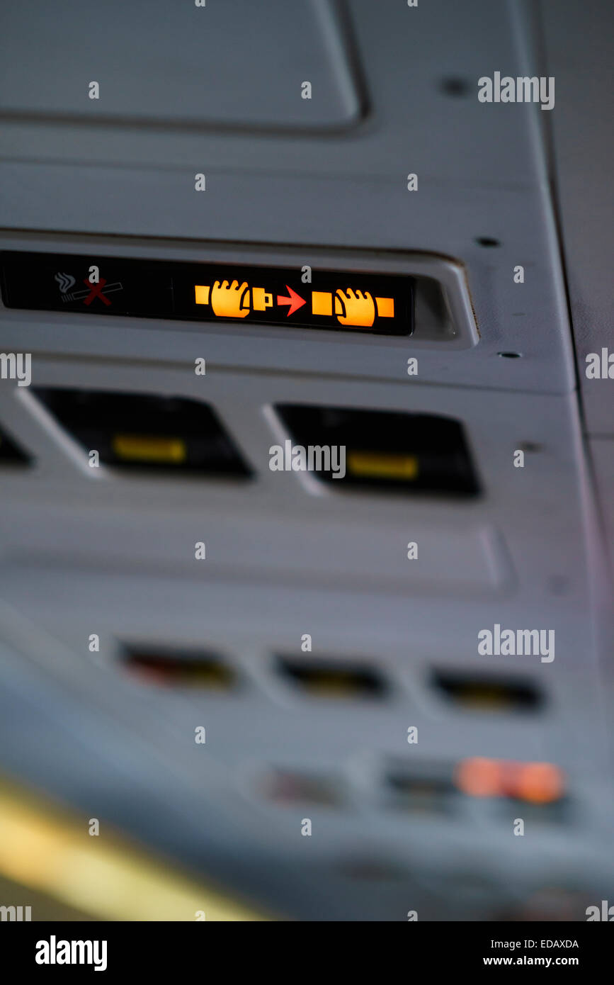 Airplane illuminated fasten seat belt sign Stock Photo - Alamy