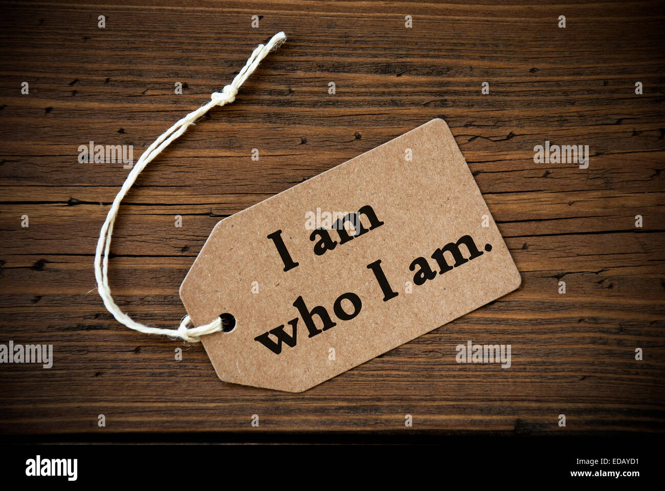 Close Up Of A Brown Label With White Ribbon On Wooden Background With ...