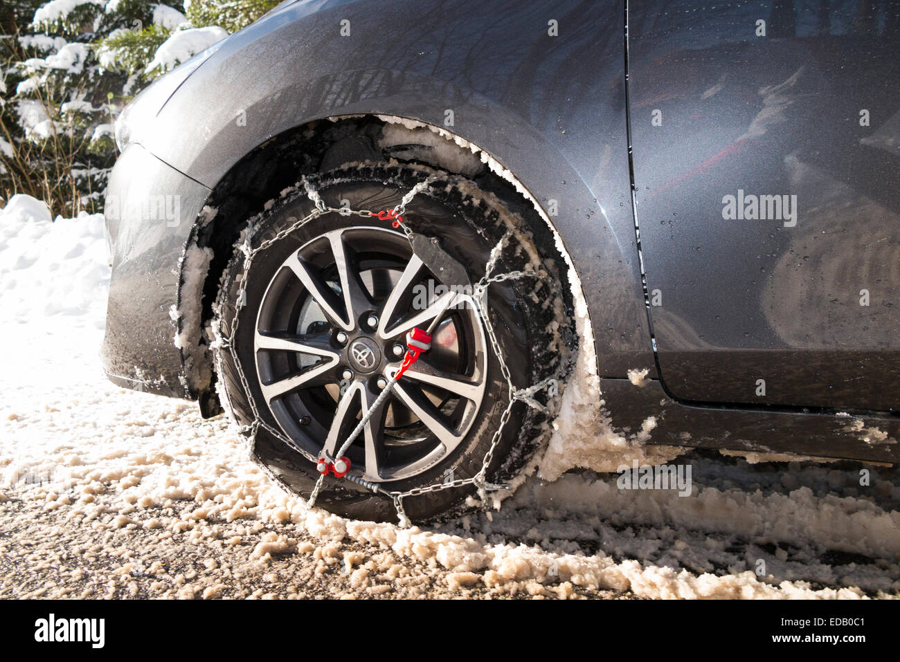 Snow chain / chains on front wheel / wheels of a car also fitted with ...